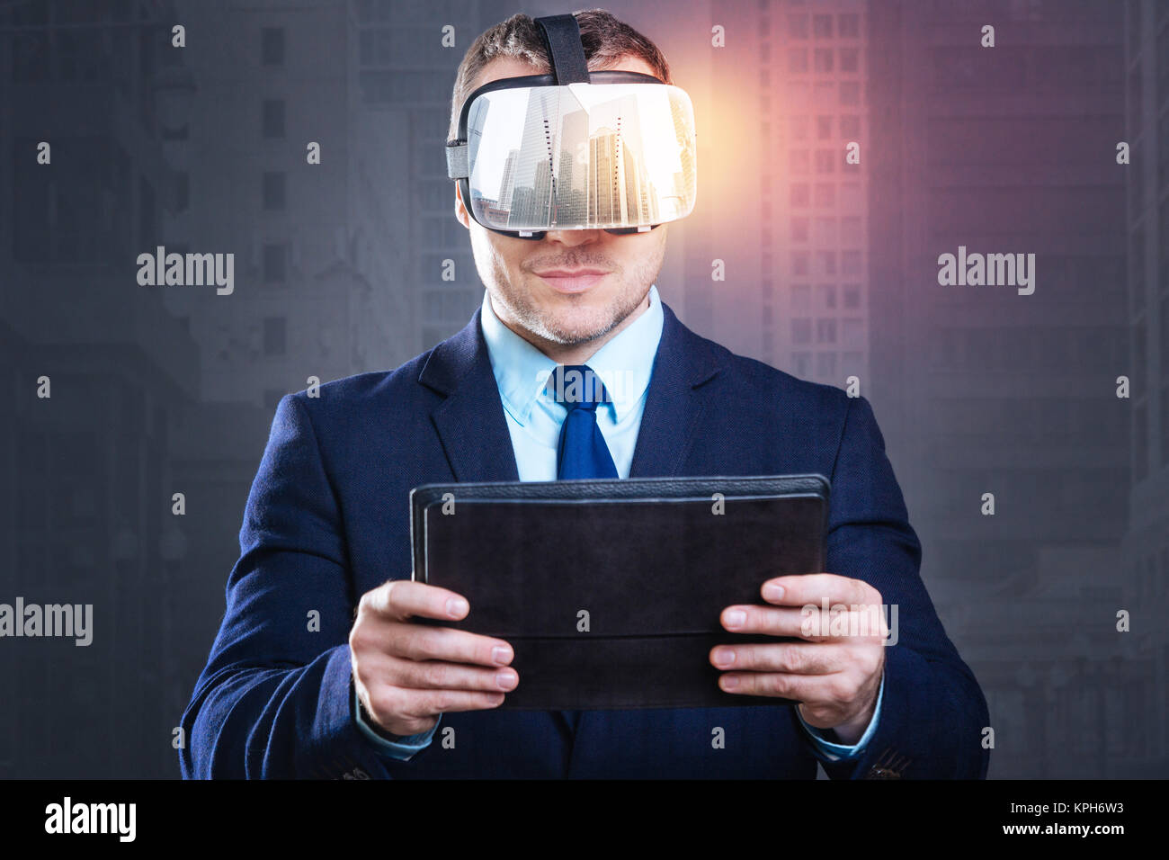 Handsome focused man looking with help of VR glasses Stock Photo - Alamy