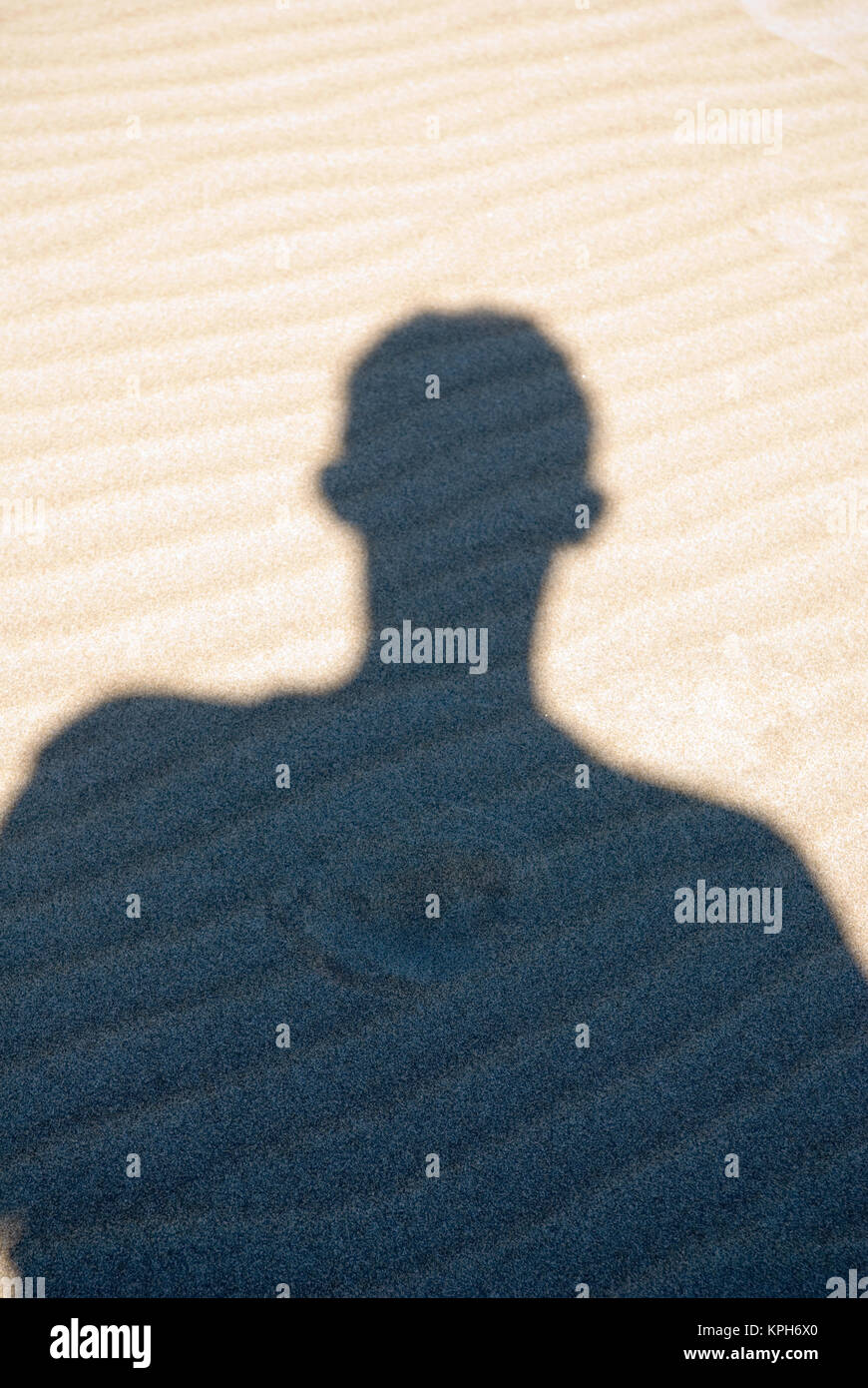 shadow of man on warm sandy beach Stock Photo - Alamy