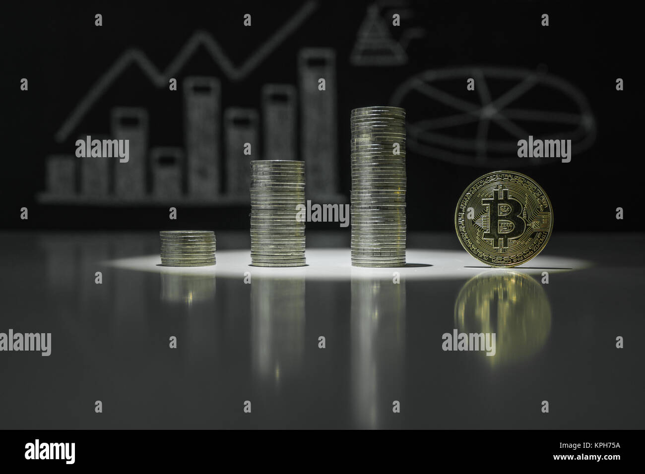 Stacks of crypto currency and gold bitcoin on the background of charts ...