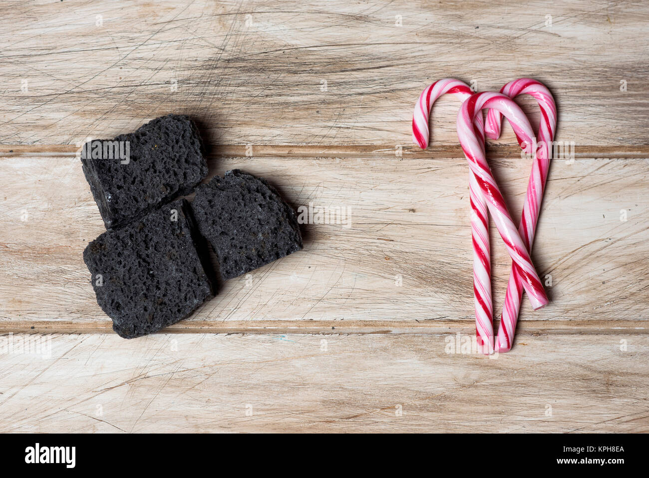 high angle view of some pieces of candy coal and some candy canes on a ...