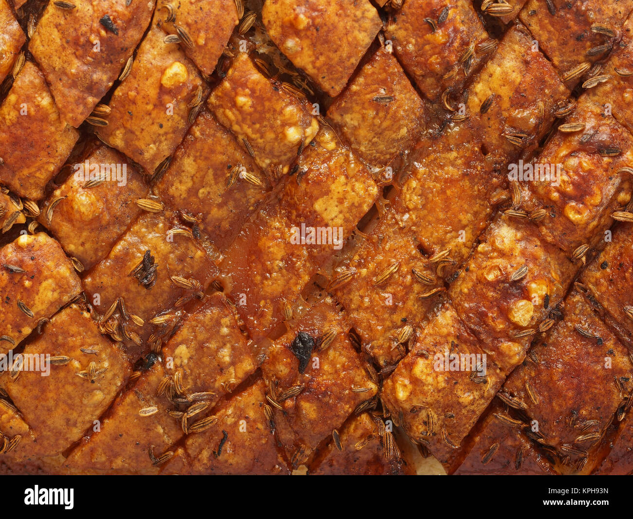 rustic scored golden roasted pork belly skin background Stock Photo - Alamy