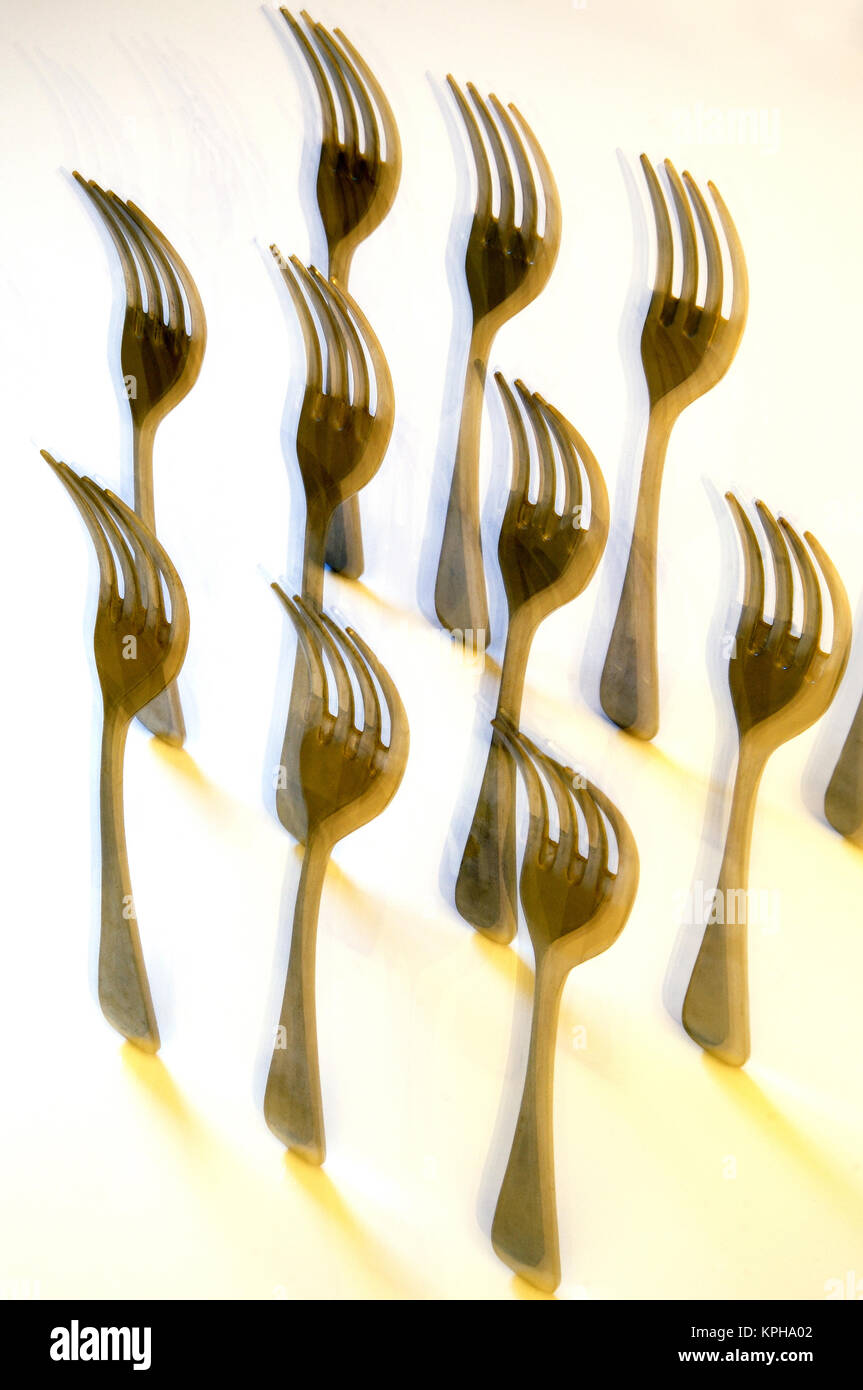 Photograph of a group of forks standing in the studio with strobe and ...