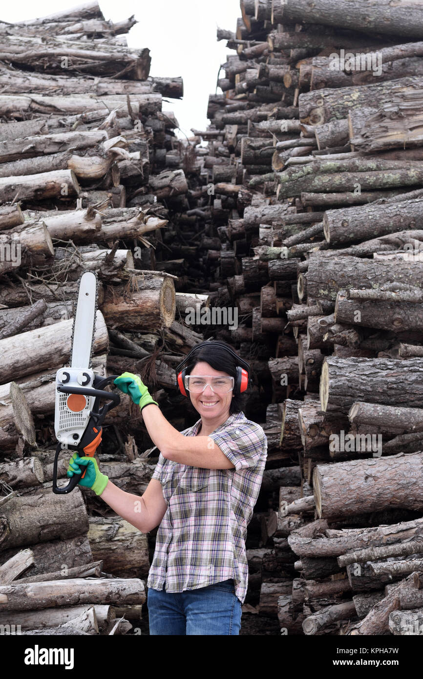 portrait of a woman with a chainsaw Stock Photo - Alamy