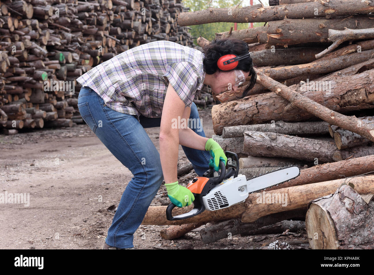 portrait of a woman with a chainsaw Stock Photo - Alamy