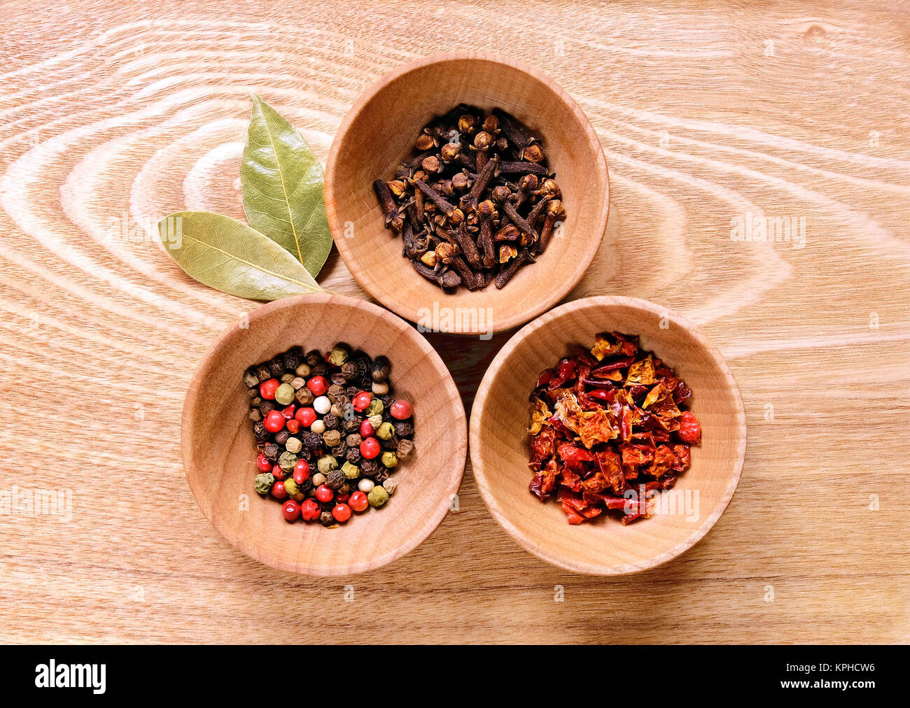 Wooden bowls with pepper, clove and paprika Stock Photo - Alamy