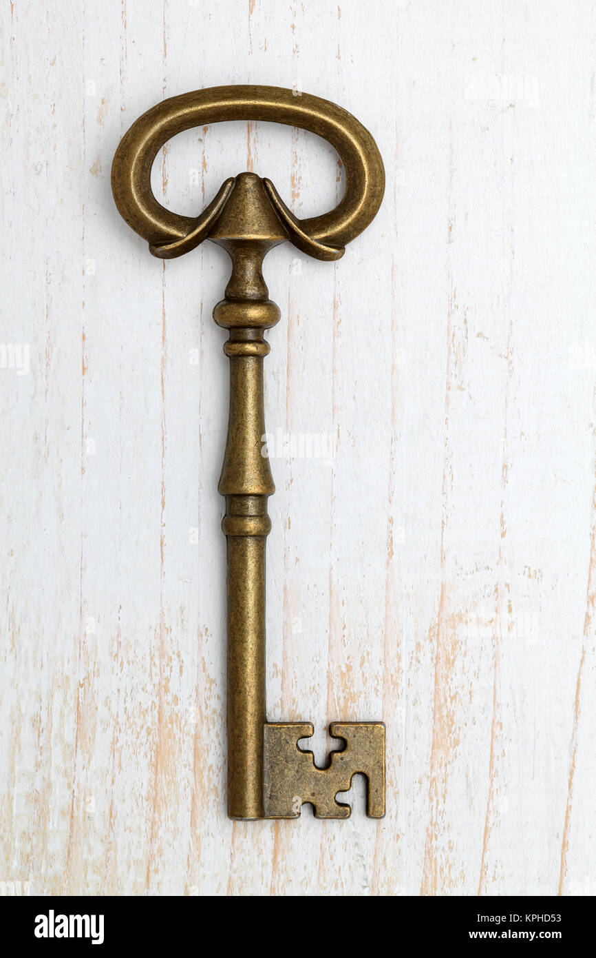 Old key on white wood background Stock Photo - Alamy