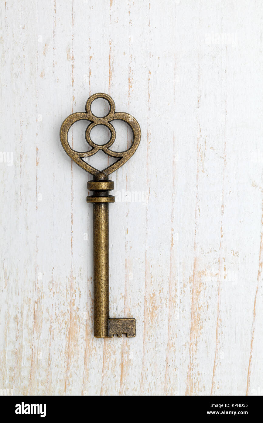 Antique key on white wood background Stock Photo - Alamy