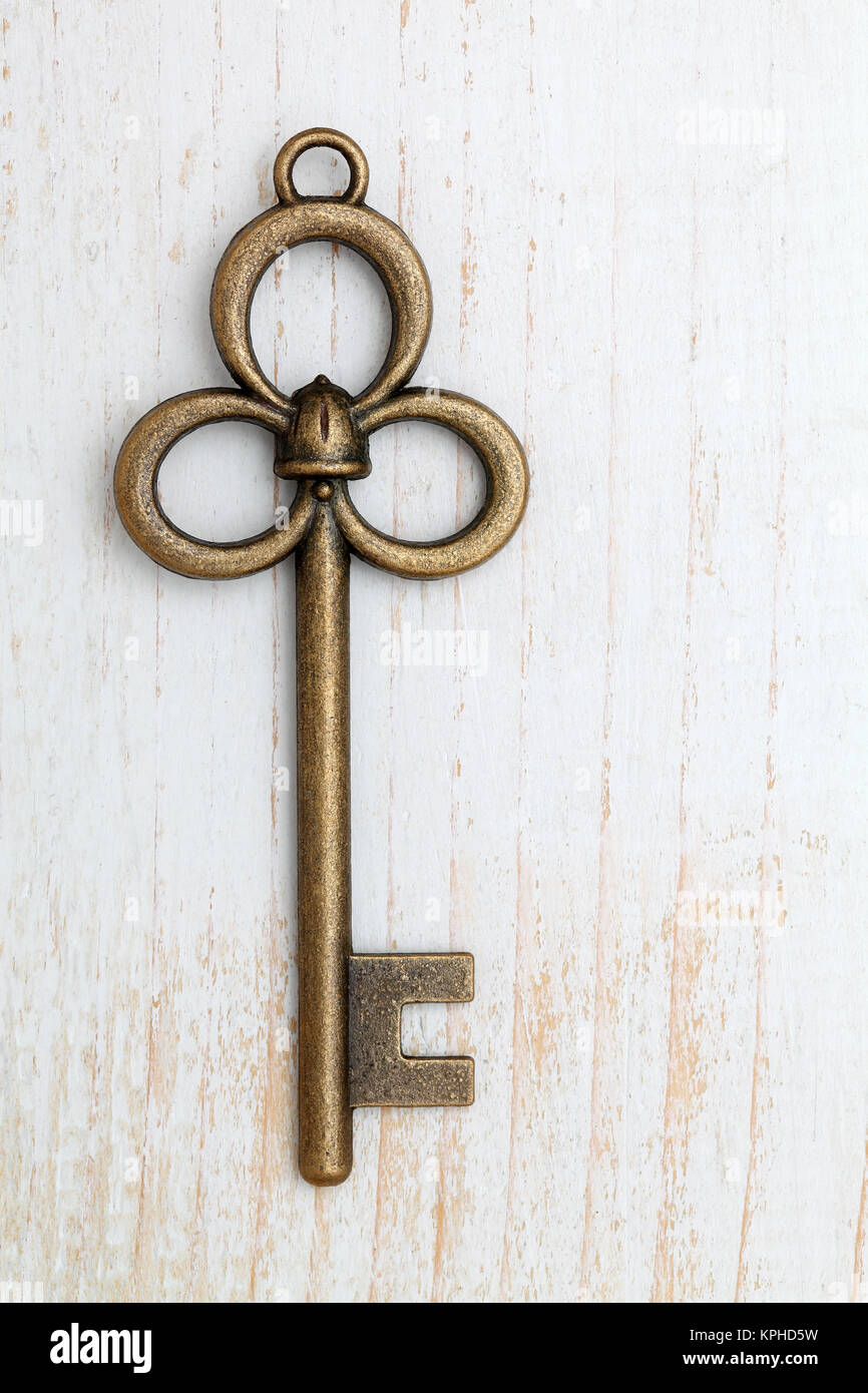 Old key on white wood background Stock Photo - Alamy