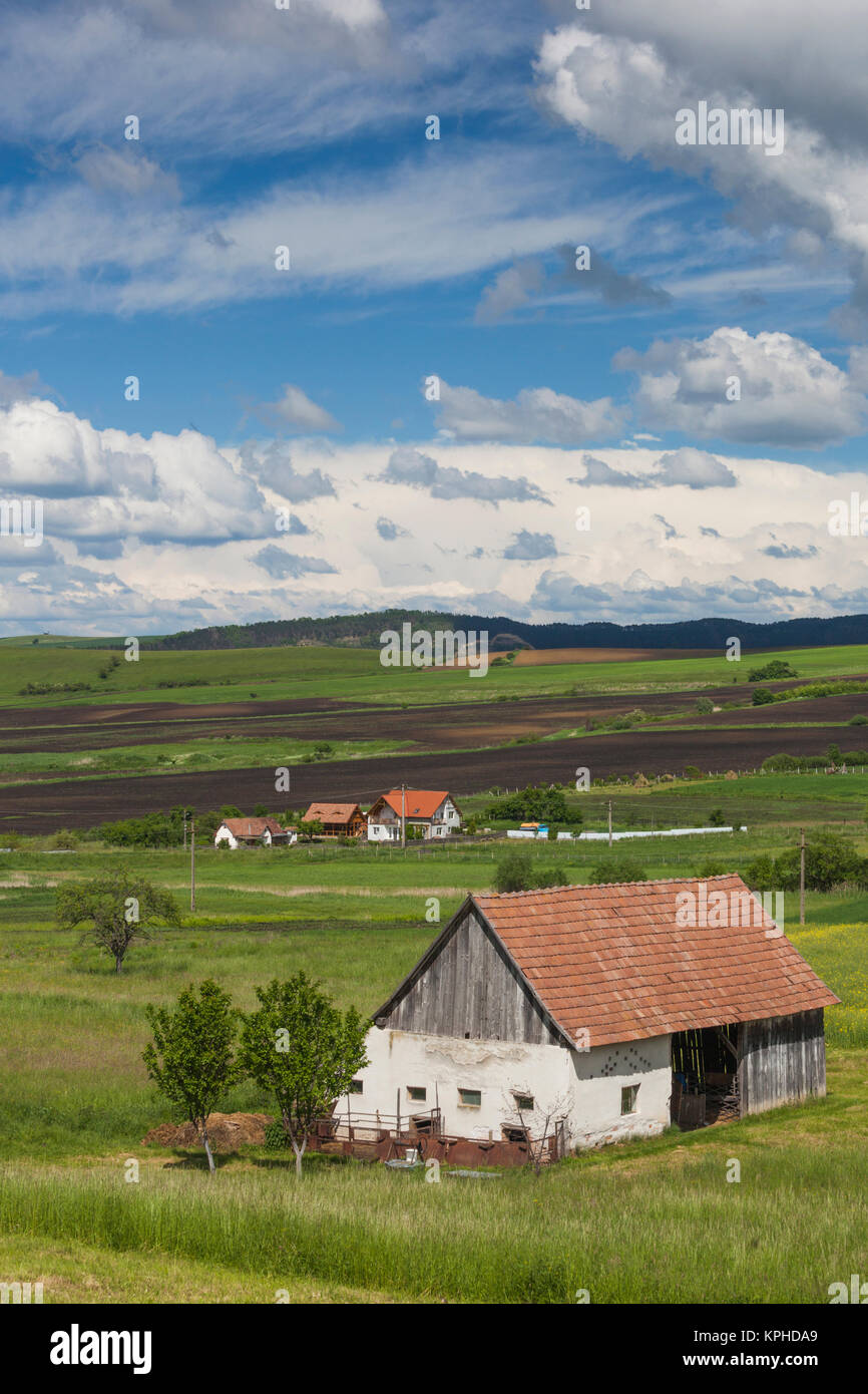 Romania, Transylvania, Tarnaveni, farm and fields, spring Stock Photo ...