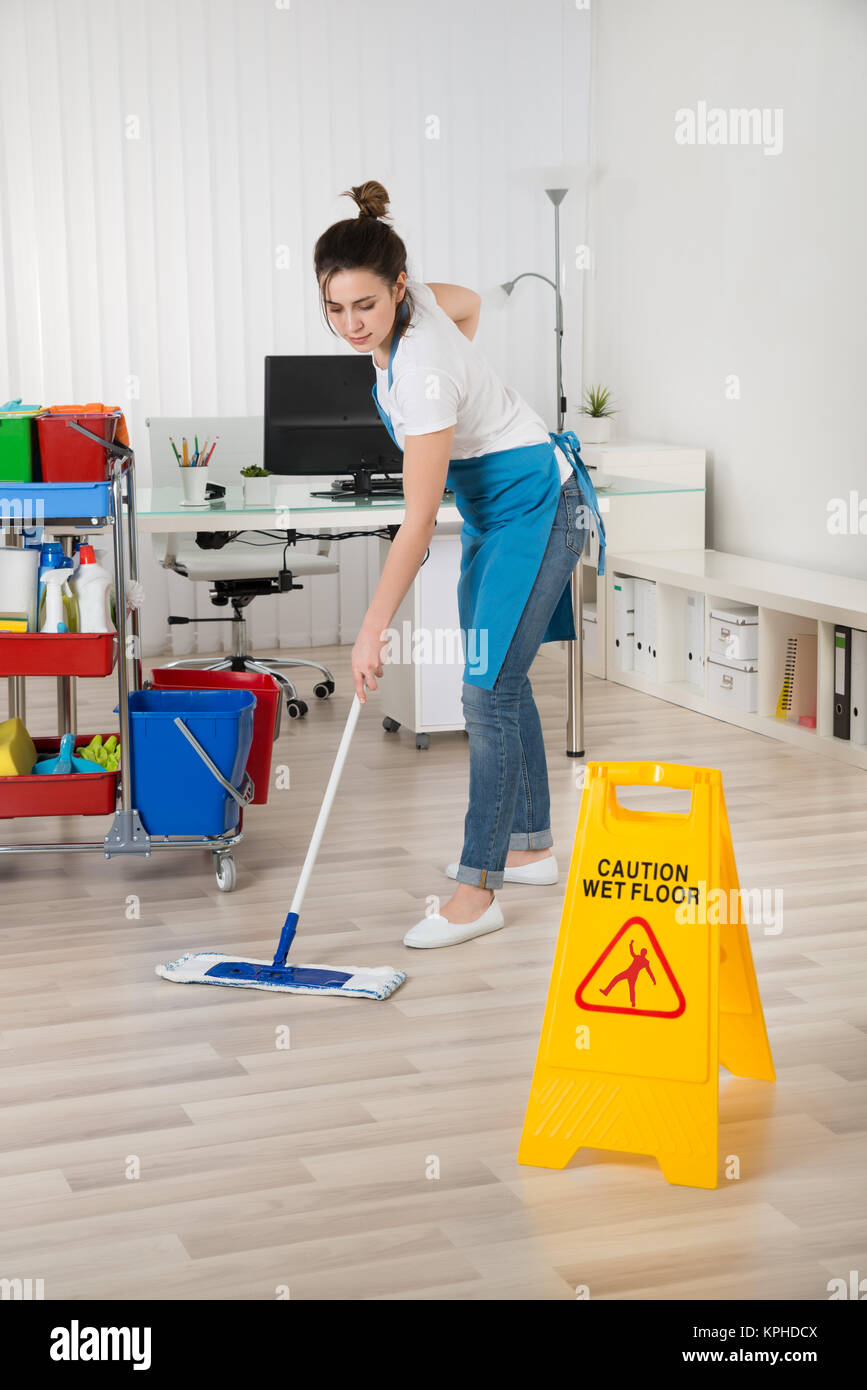 Female Janitor Mopping Wooden Floor Stock Photo - Alamy