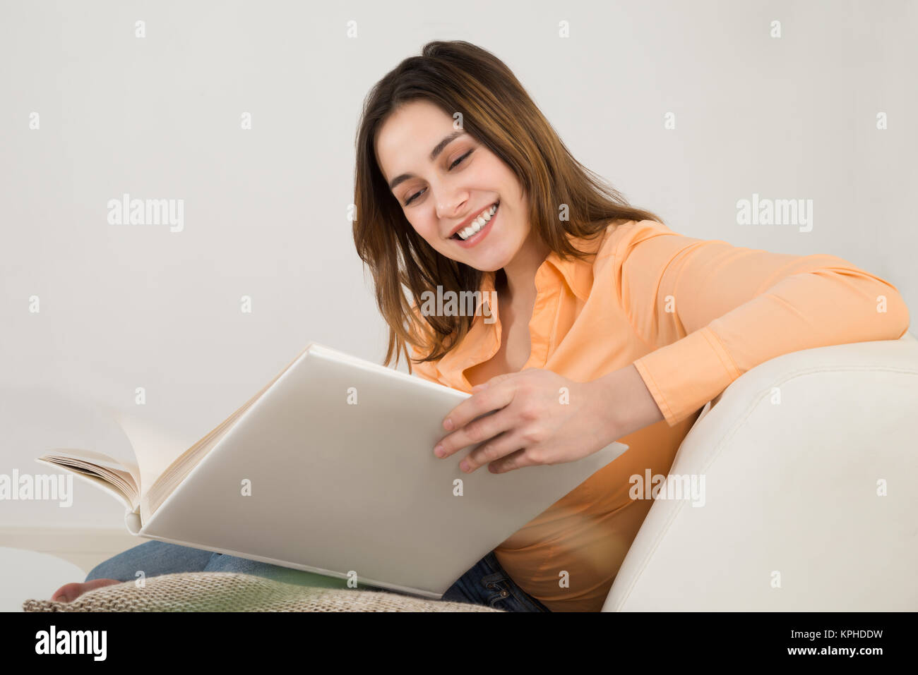 Woman Looking At Photo Album Stock Photo - Alamy