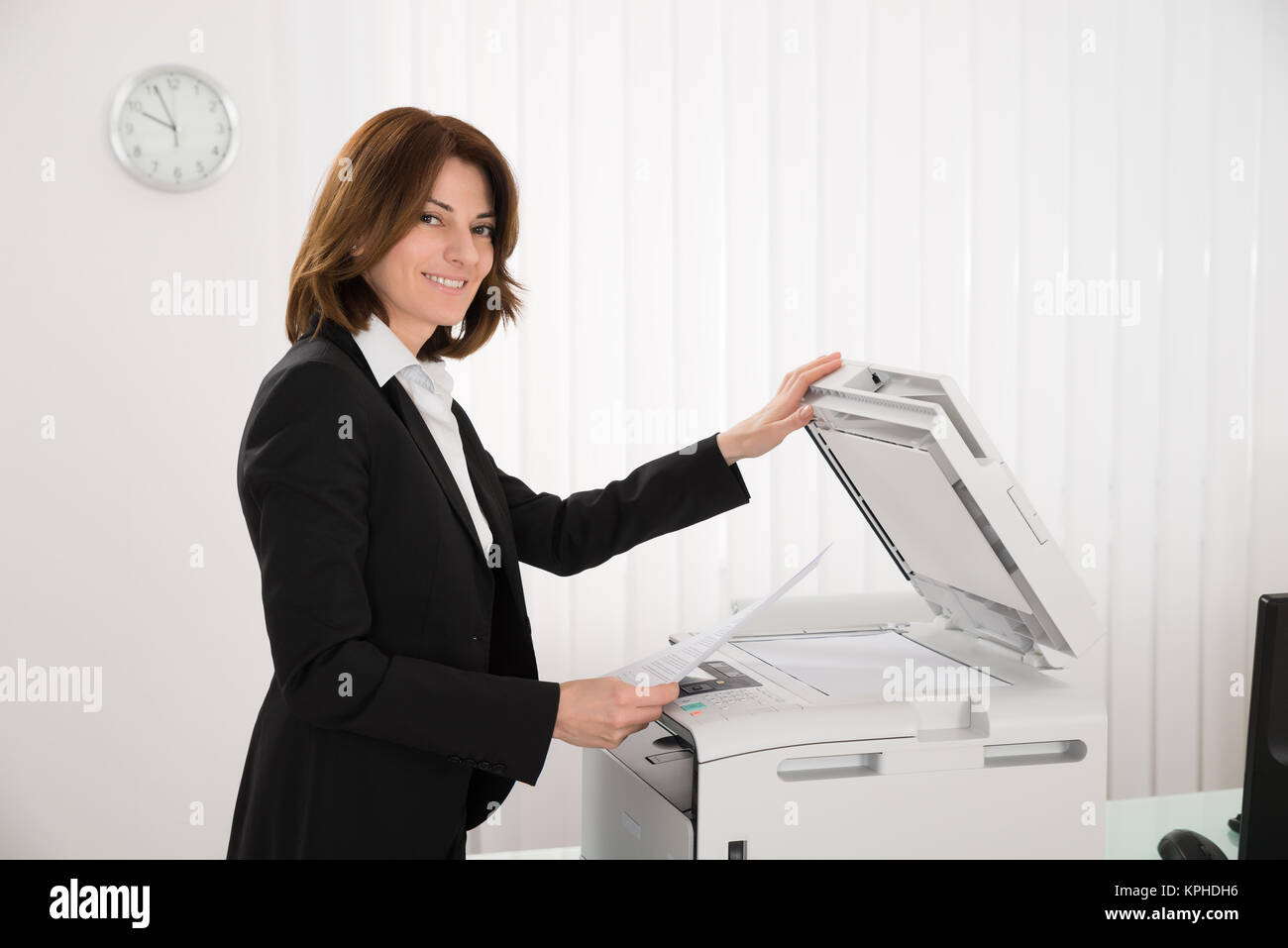 Businesswoman Copying Paper On Photocopy Machine Stock Photo - Alamy