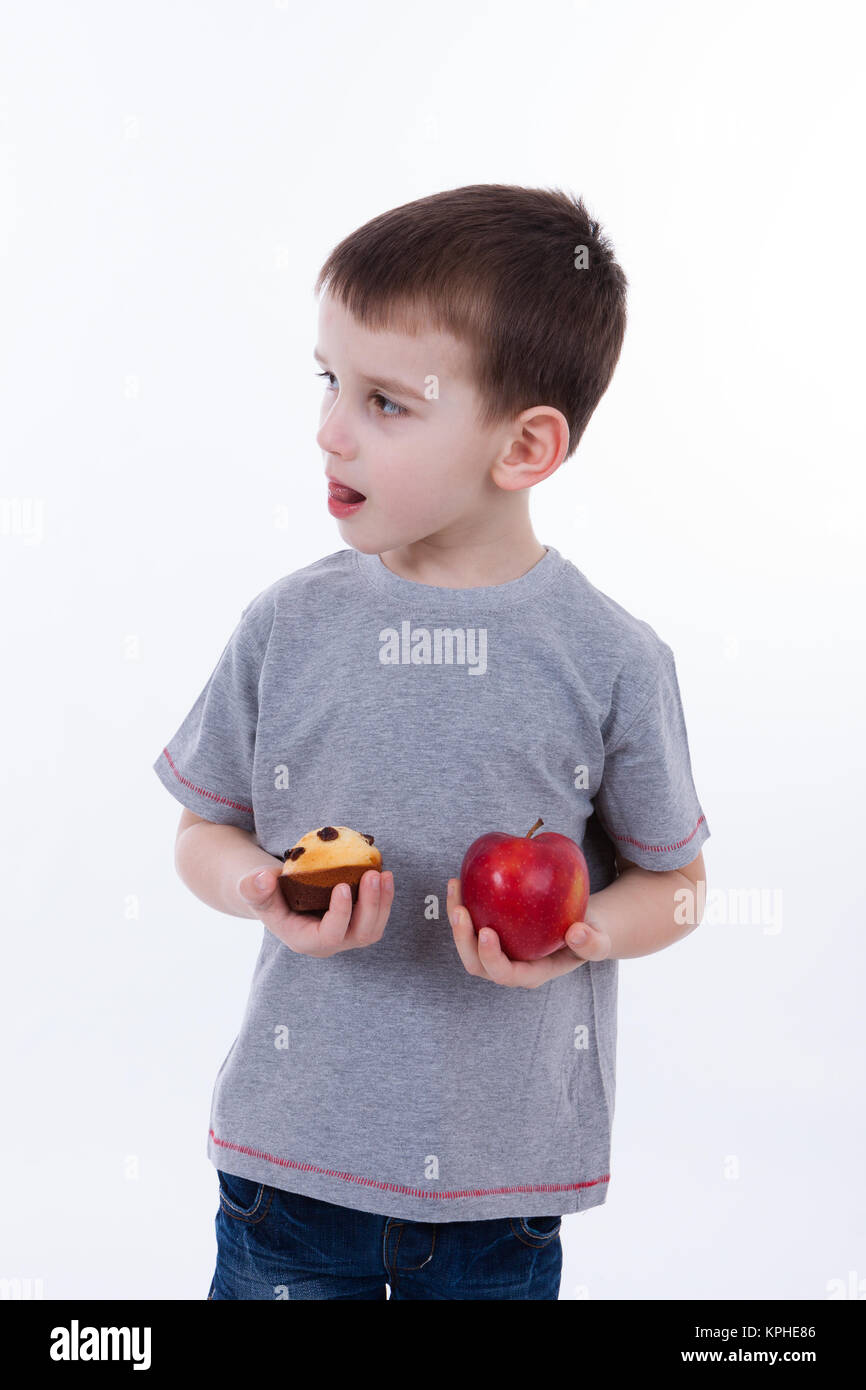 little boy with food isolated on white background - apple or a muffin ...