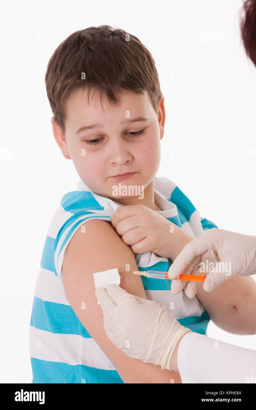 Doctor giving a child injection in arm on isolated image Stock Photo ...