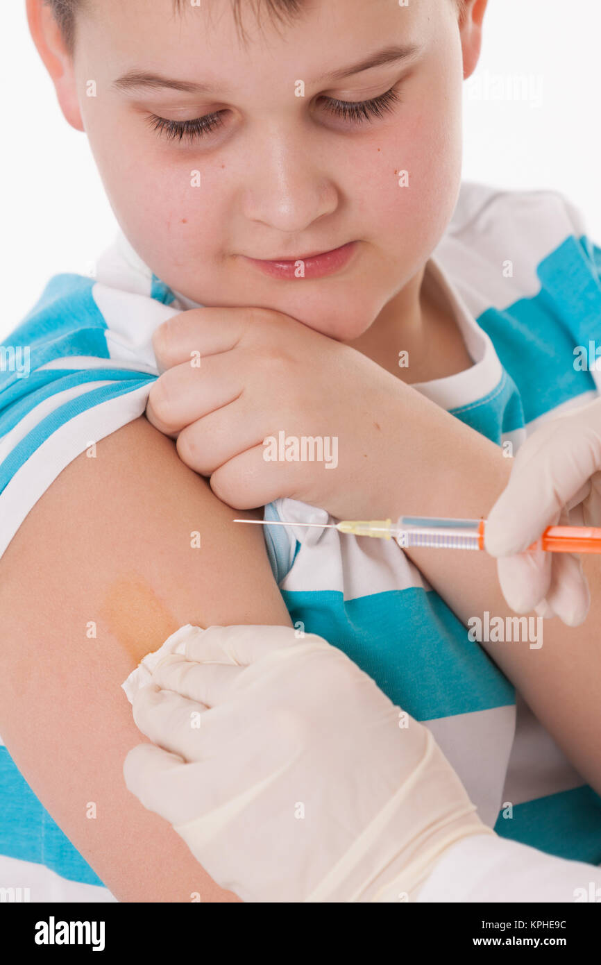 Doctor giving a child injection in arm on isolated image Stock Photo ...