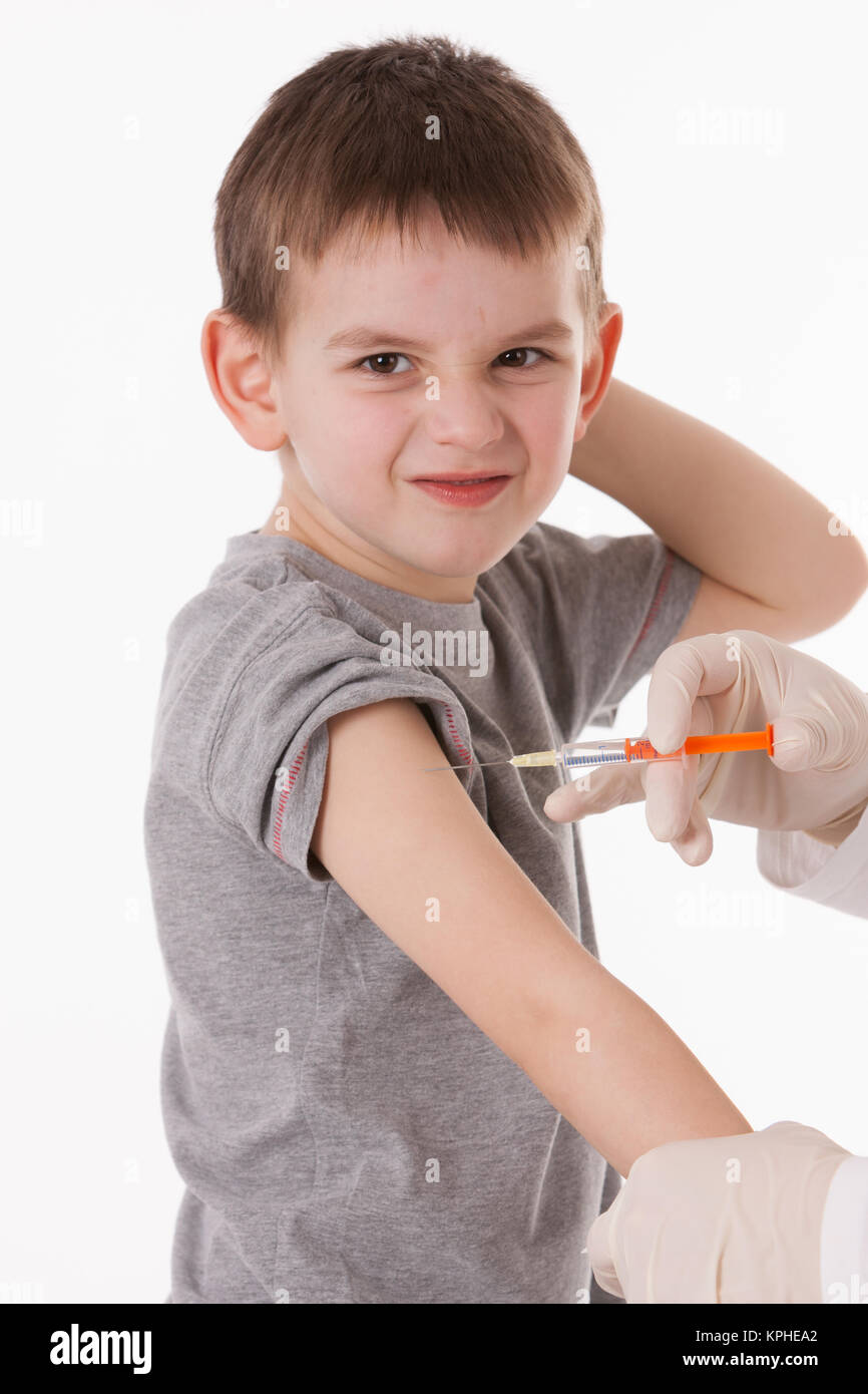 Doctor giving a child injection in arm on isolated image Stock Photo ...