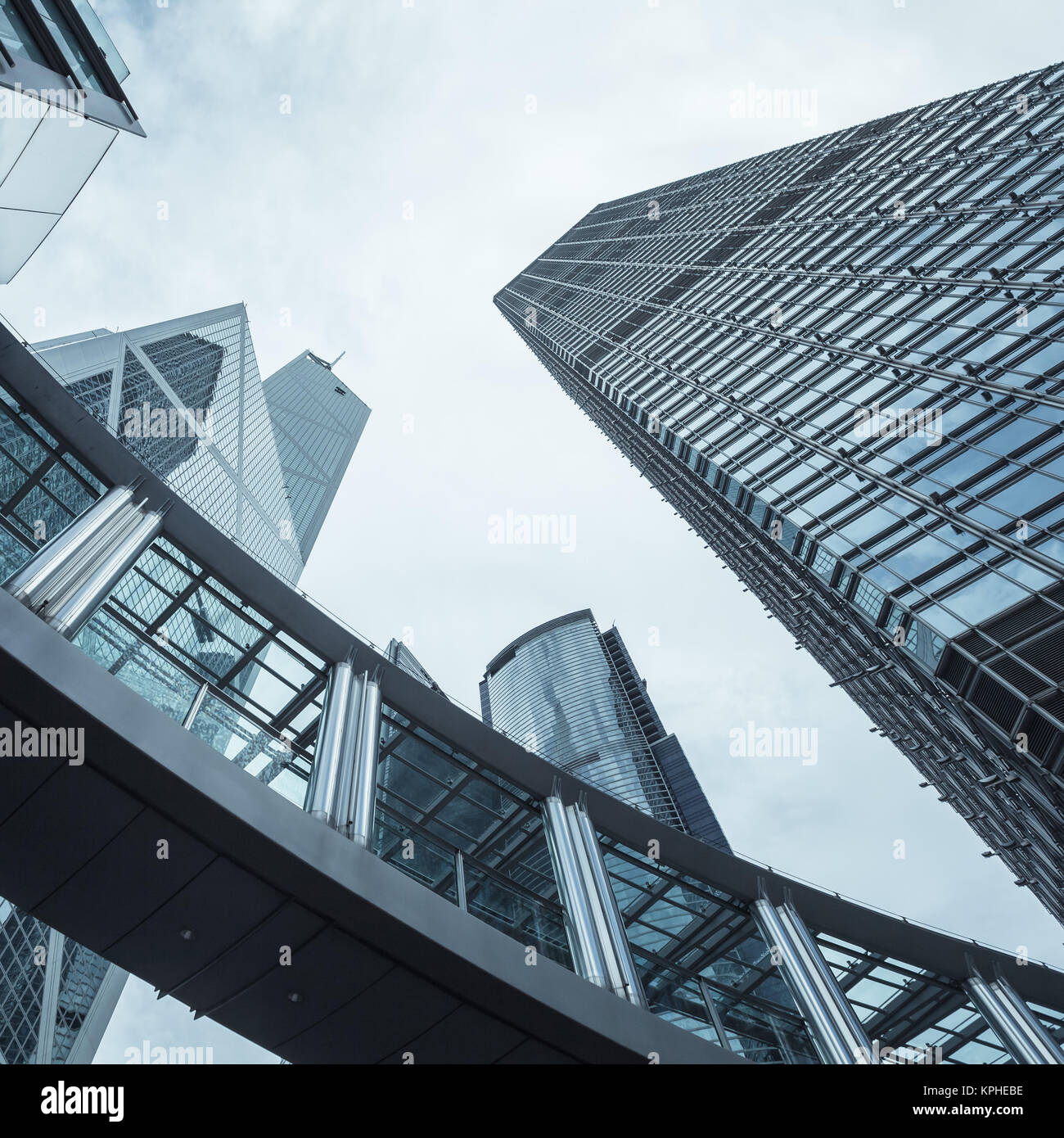 Hong Kong city skyline with skyscrapers under cloudy sky. Square blue ...