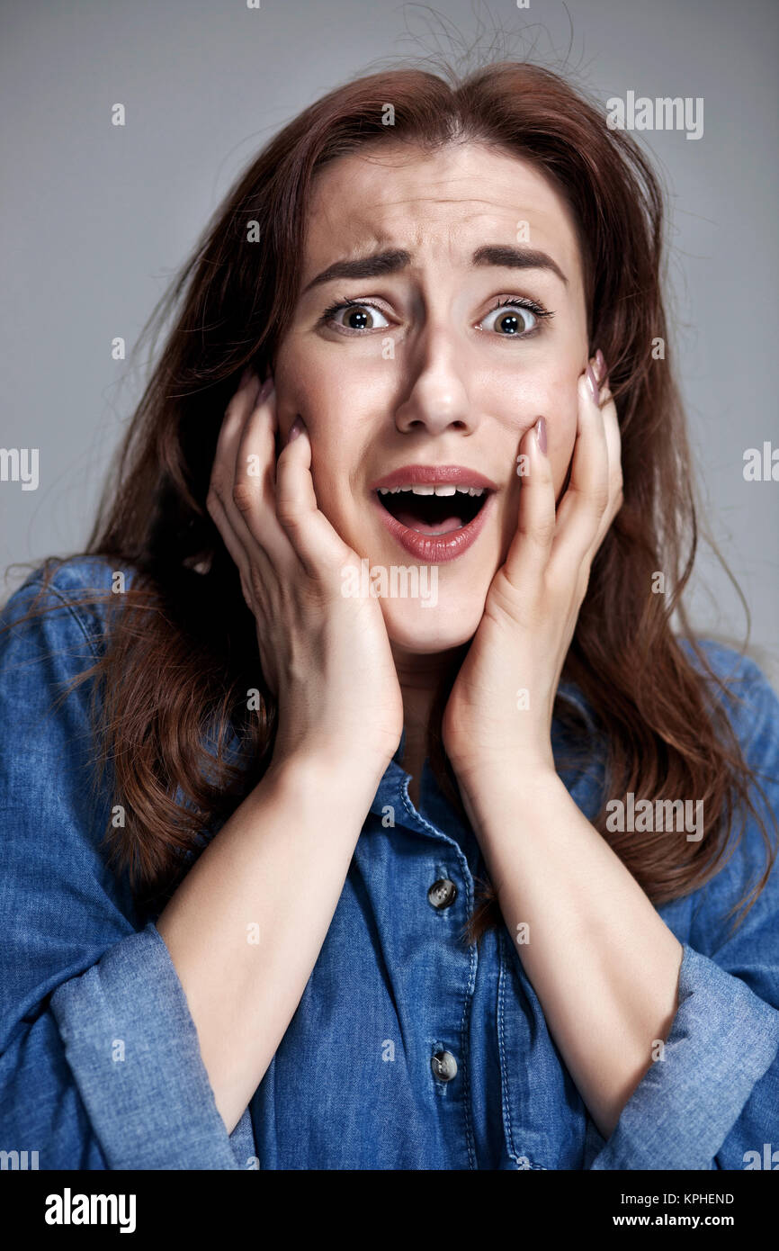 Portrait of young woman with shocked facial expression Stock Photo - Alamy