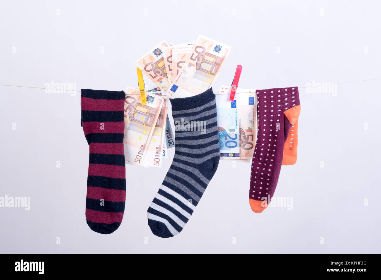photo showing the savings in euros hidden in a sock Stock Photo - Alamy