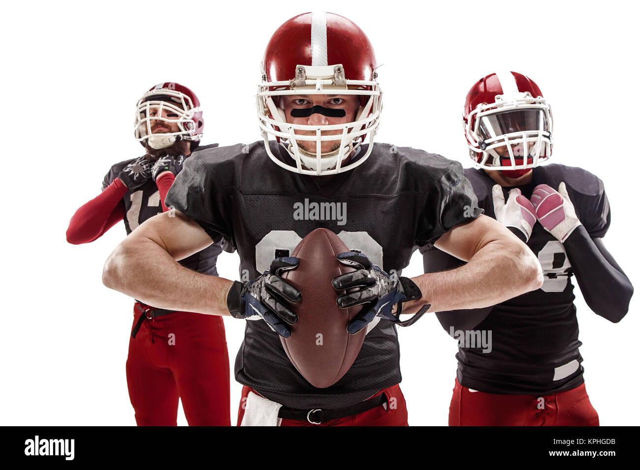 The three american football players posing with ball on white ...