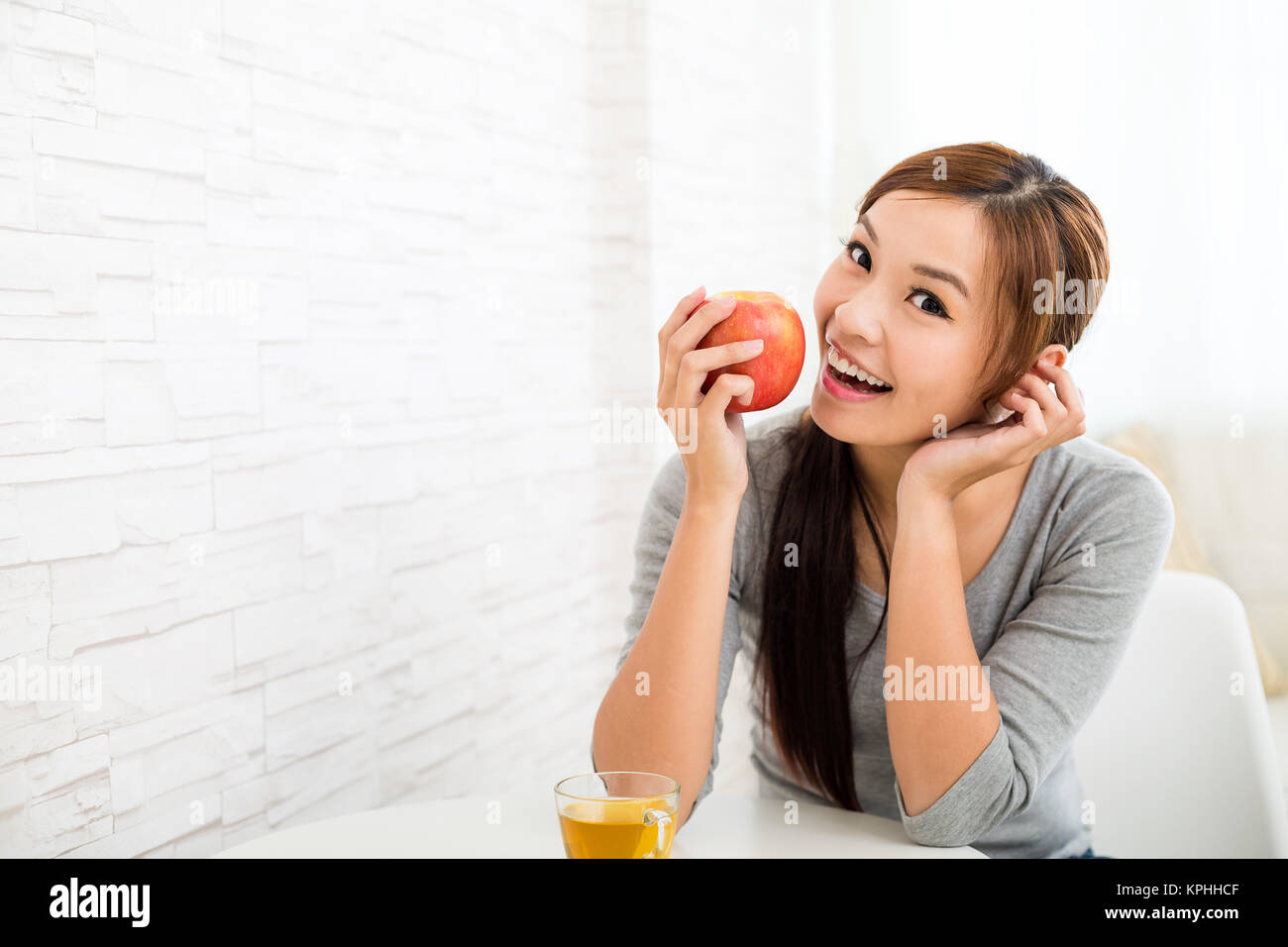 Woman eating an apple Stock Photo - Alamy