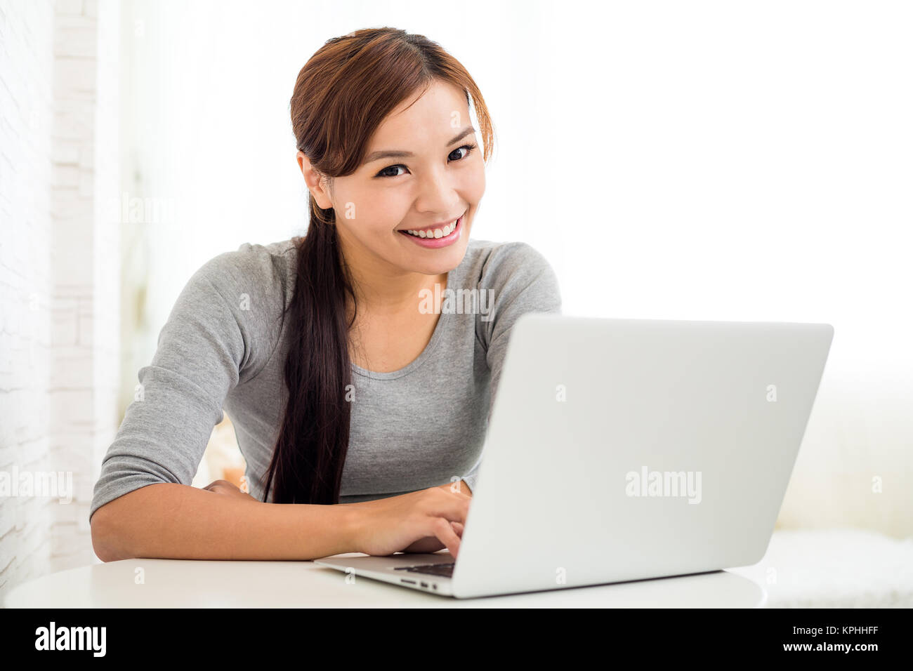 Woman using laptop computer Stock Photo - Alamy