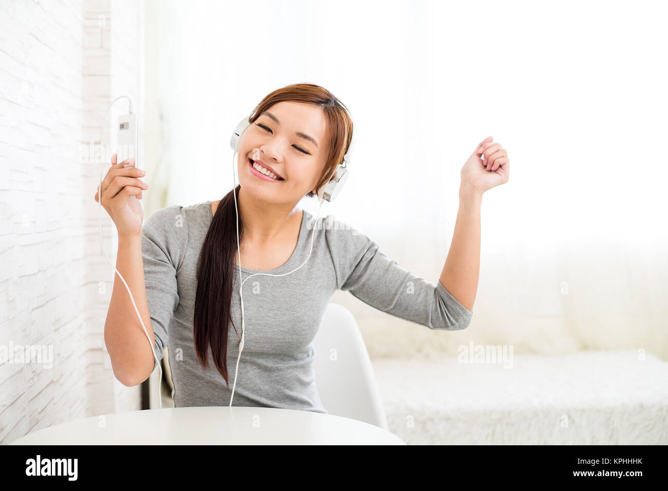 Excited woman listen to music Stock Photo - Alamy