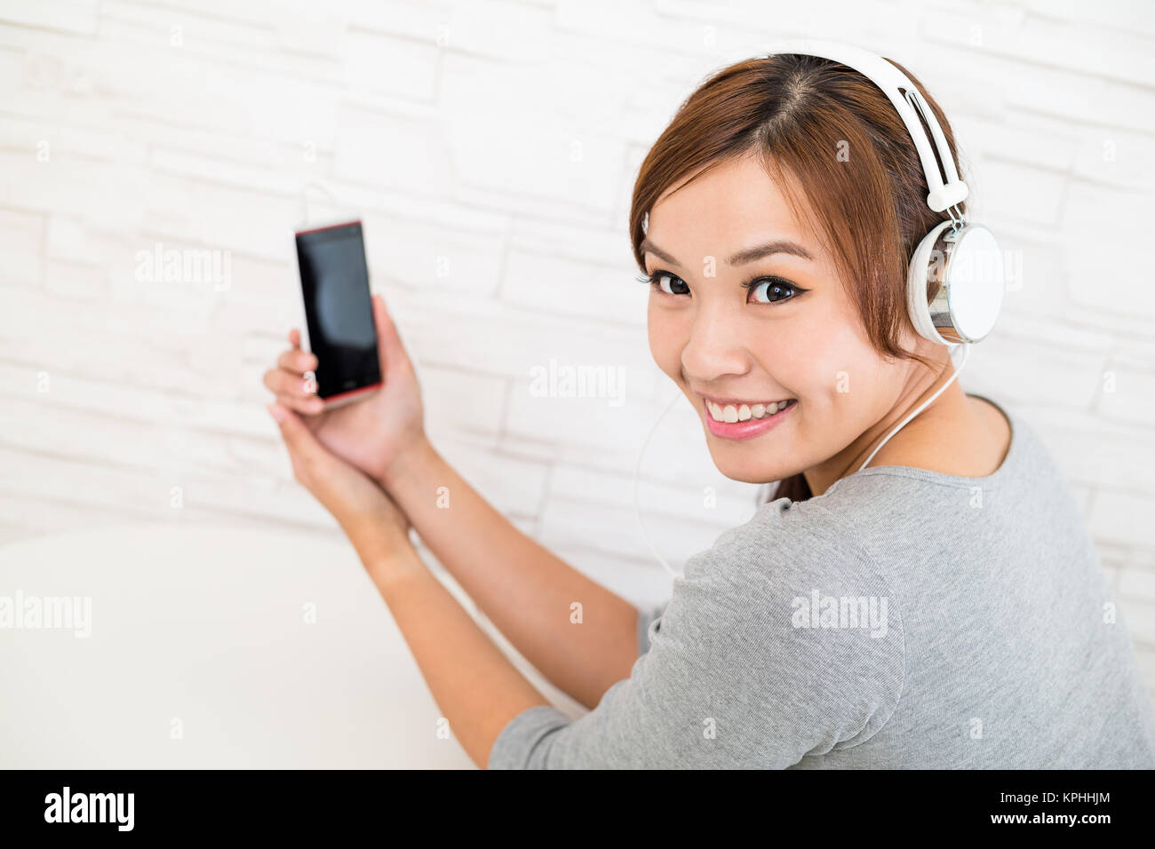 Woman listen to music with headphone Stock Photo - Alamy