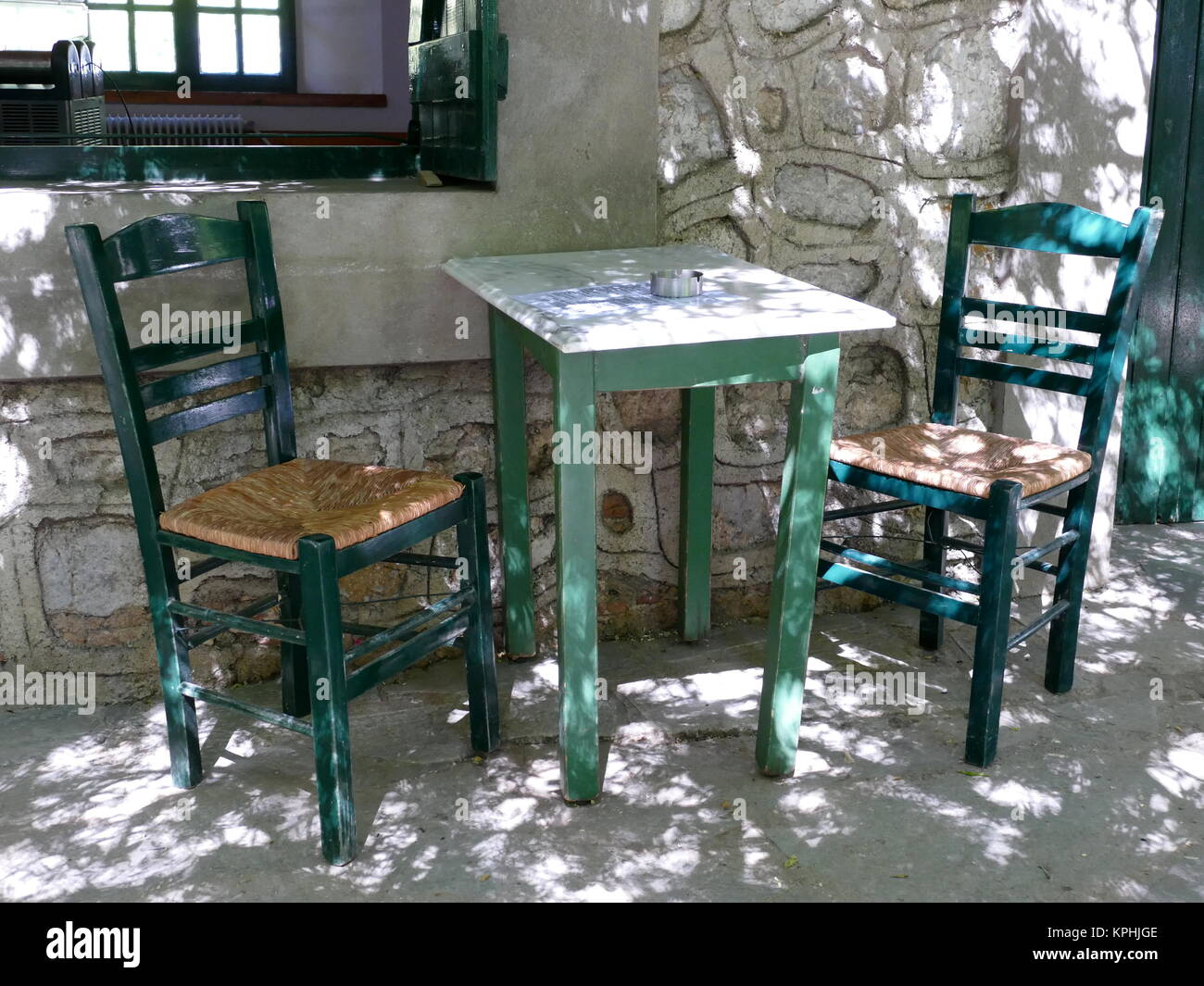 Table and two chairs outside a cafe in Athens, Greece Stock Photo - Alamy