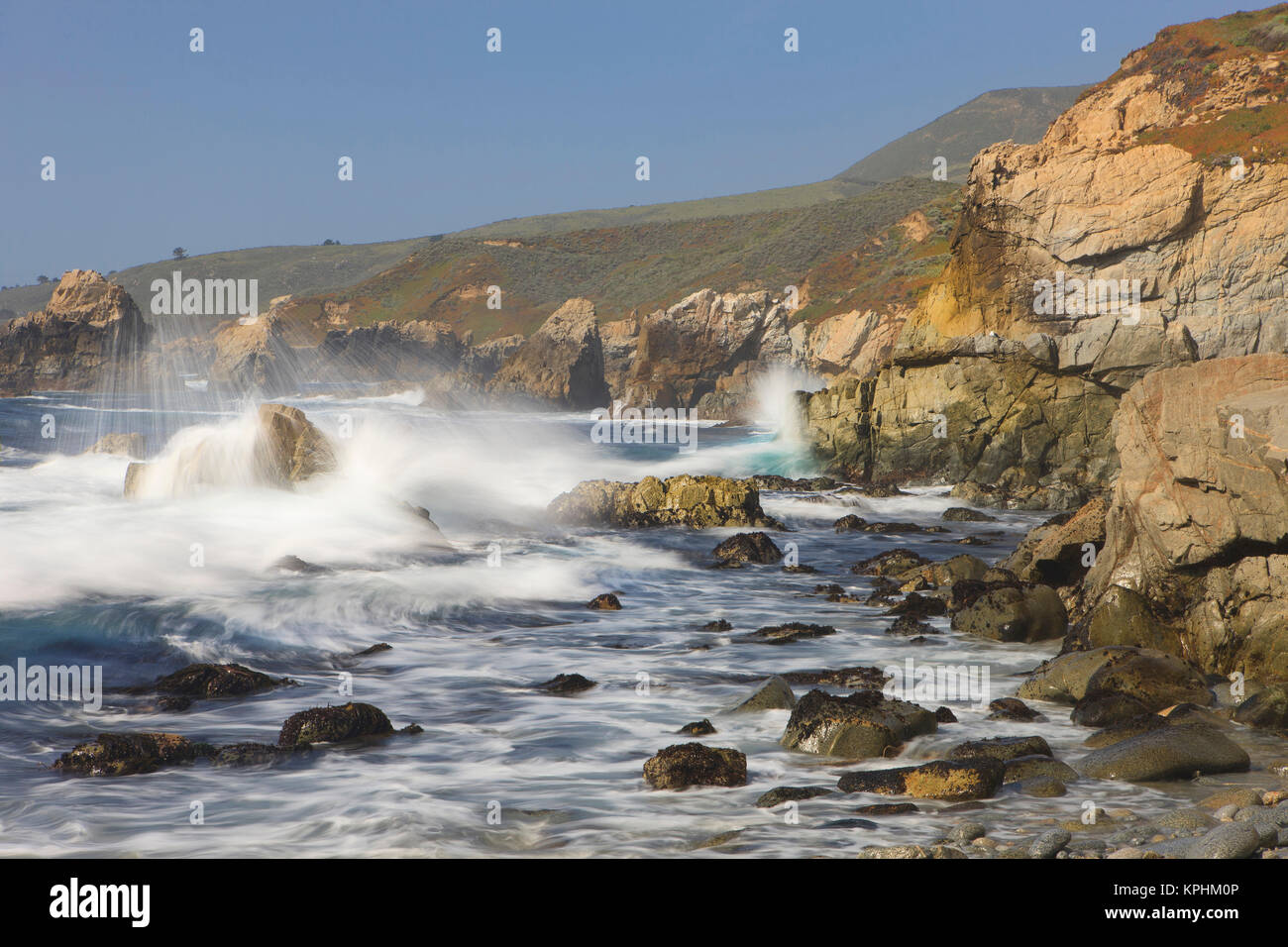 Foam thrown in the air when hitting rocks. Garrapata State Park. View ...