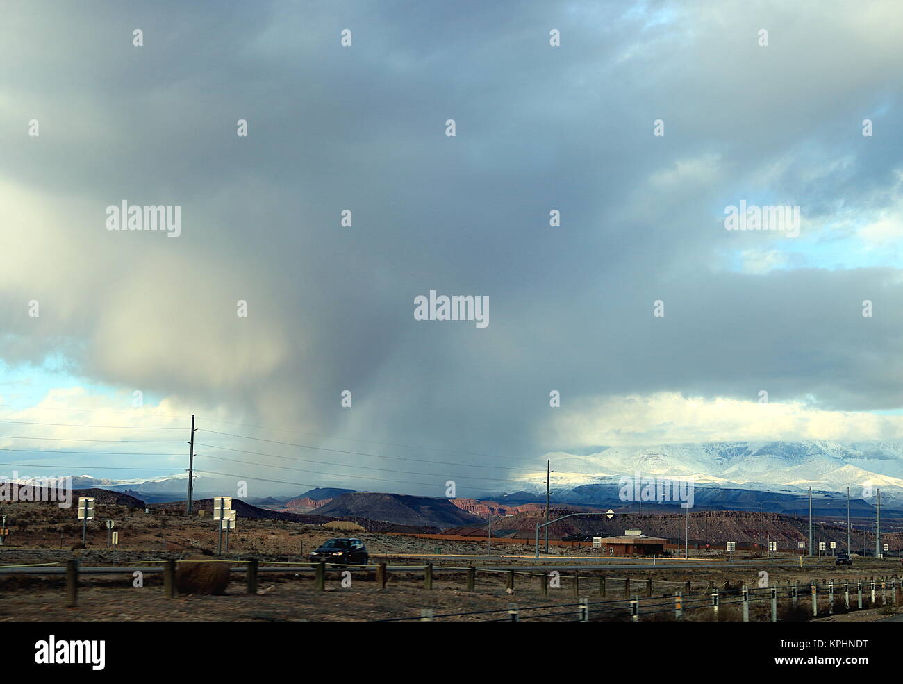 The incoming storm with thick cloud formation passing over the road and ...