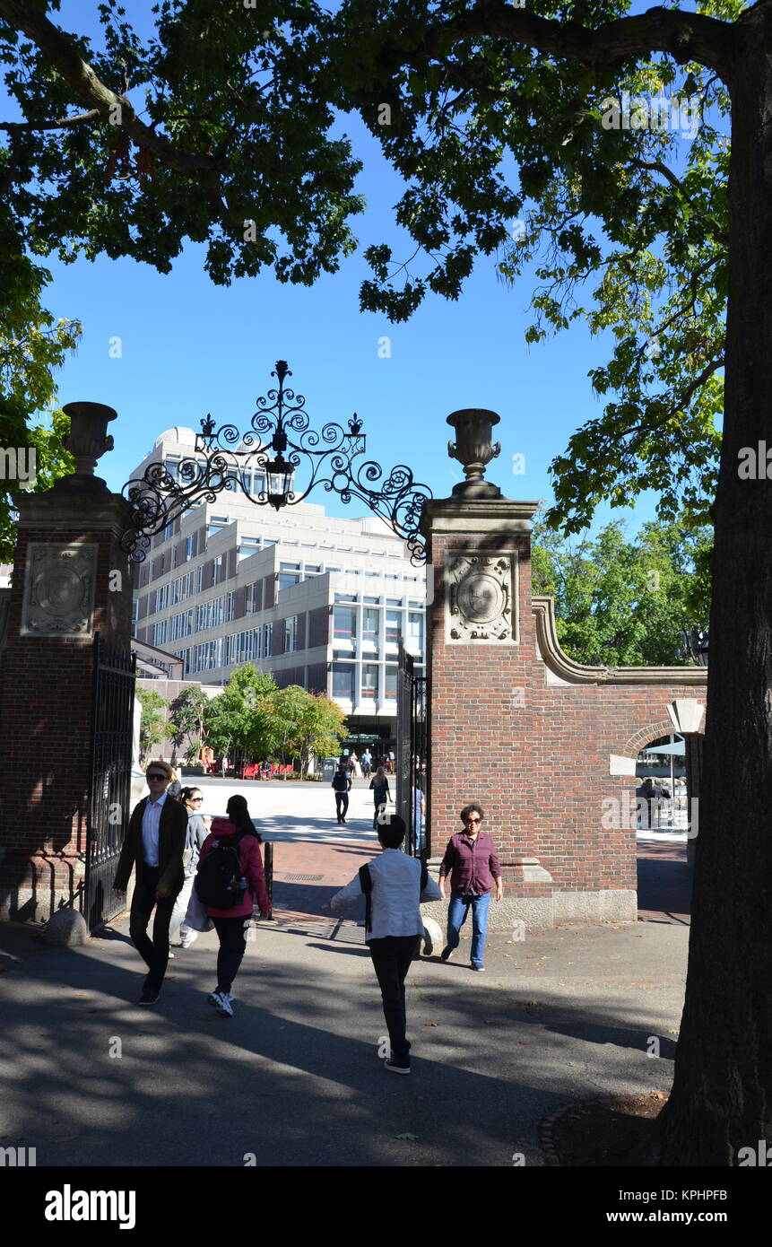 Students and tourists walk through entrance gates of Harvard Yard to ...