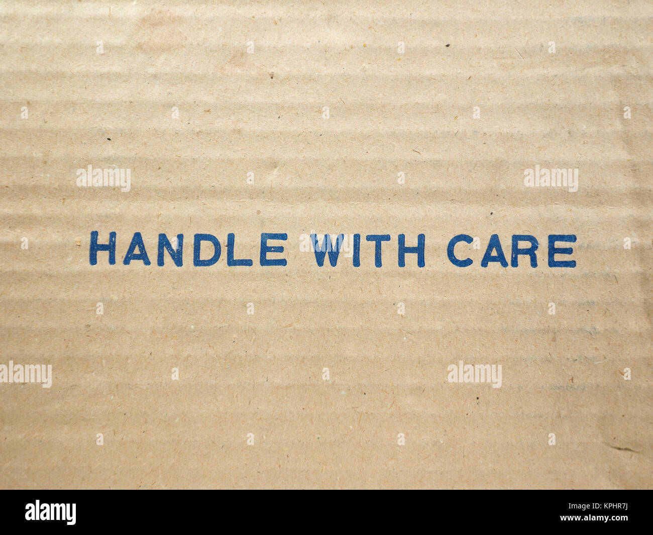 Handle with care tag on a corrugated cardboard packet Stock Photo - Alamy