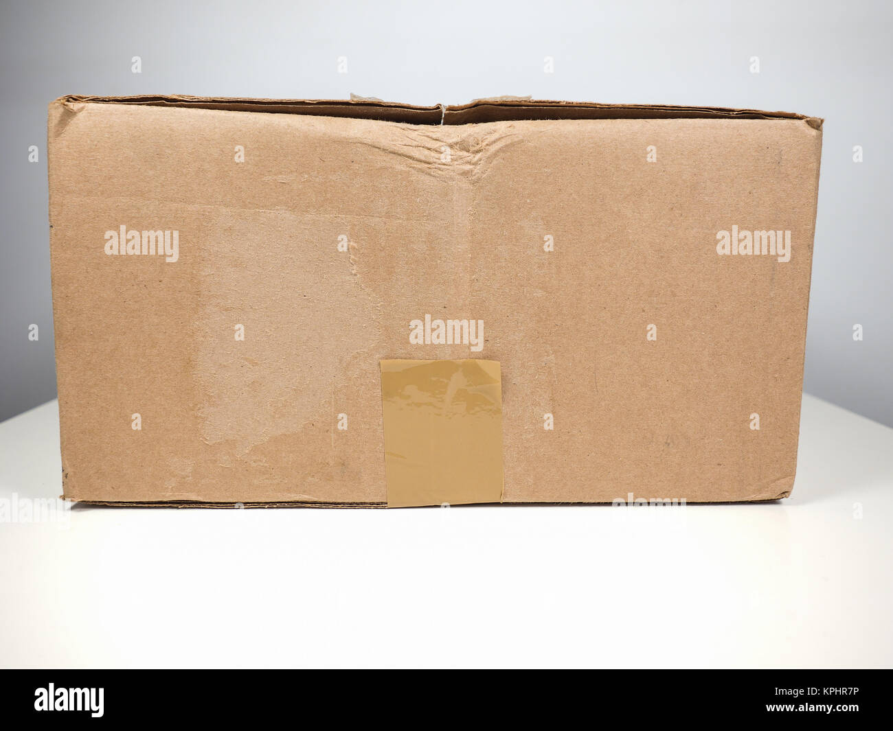 Small brown packet corrugated cardboard parcel for mail shipping on a ...