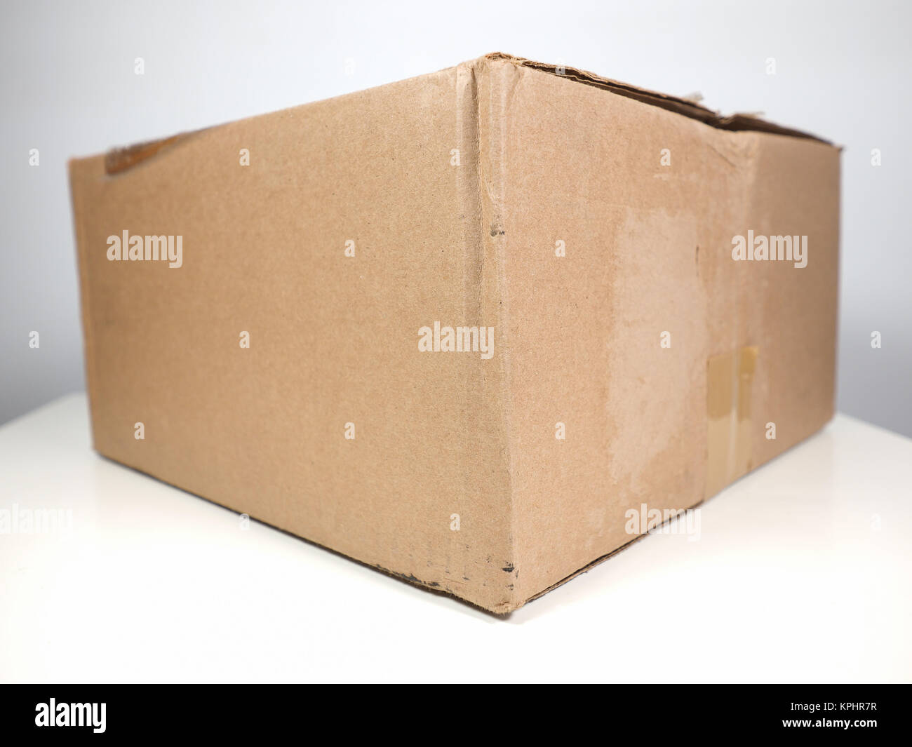 Small brown packet corrugated cardboard parcel for mail shipping on a ...