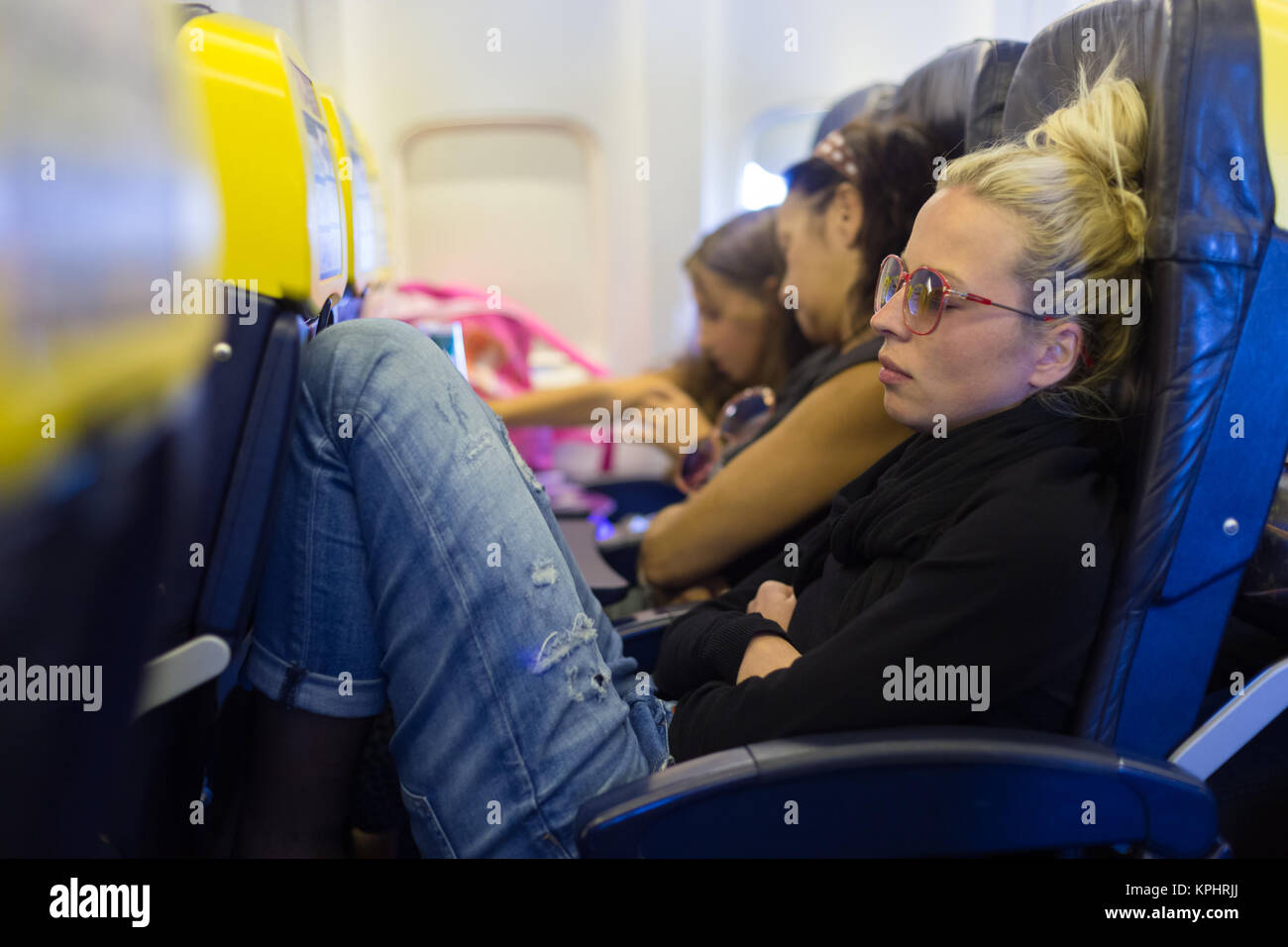 Tired lady napping on airplane Stock Photo - Alamy
