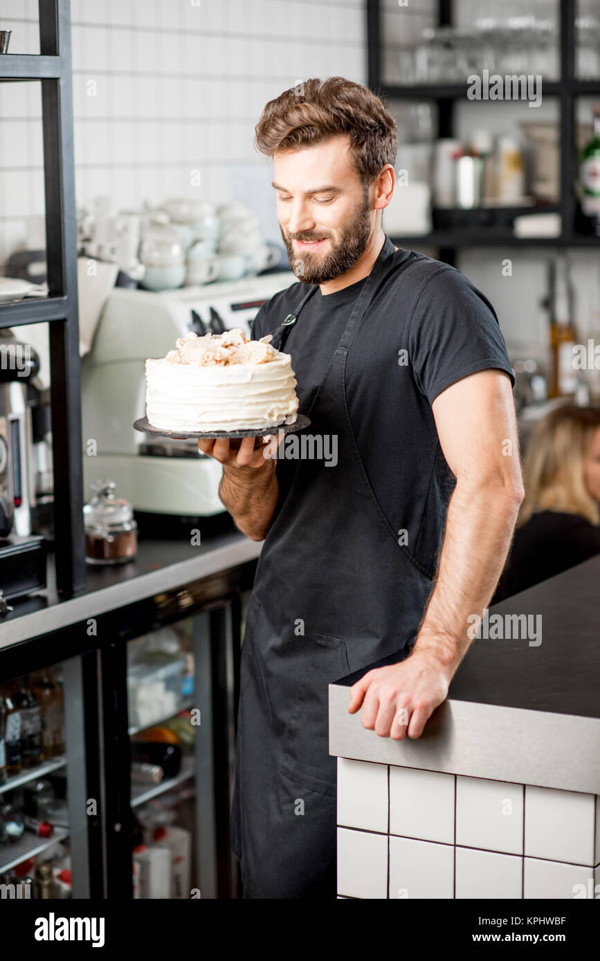 Confectioner holding chocolate cake hi-res stock photography and images ...