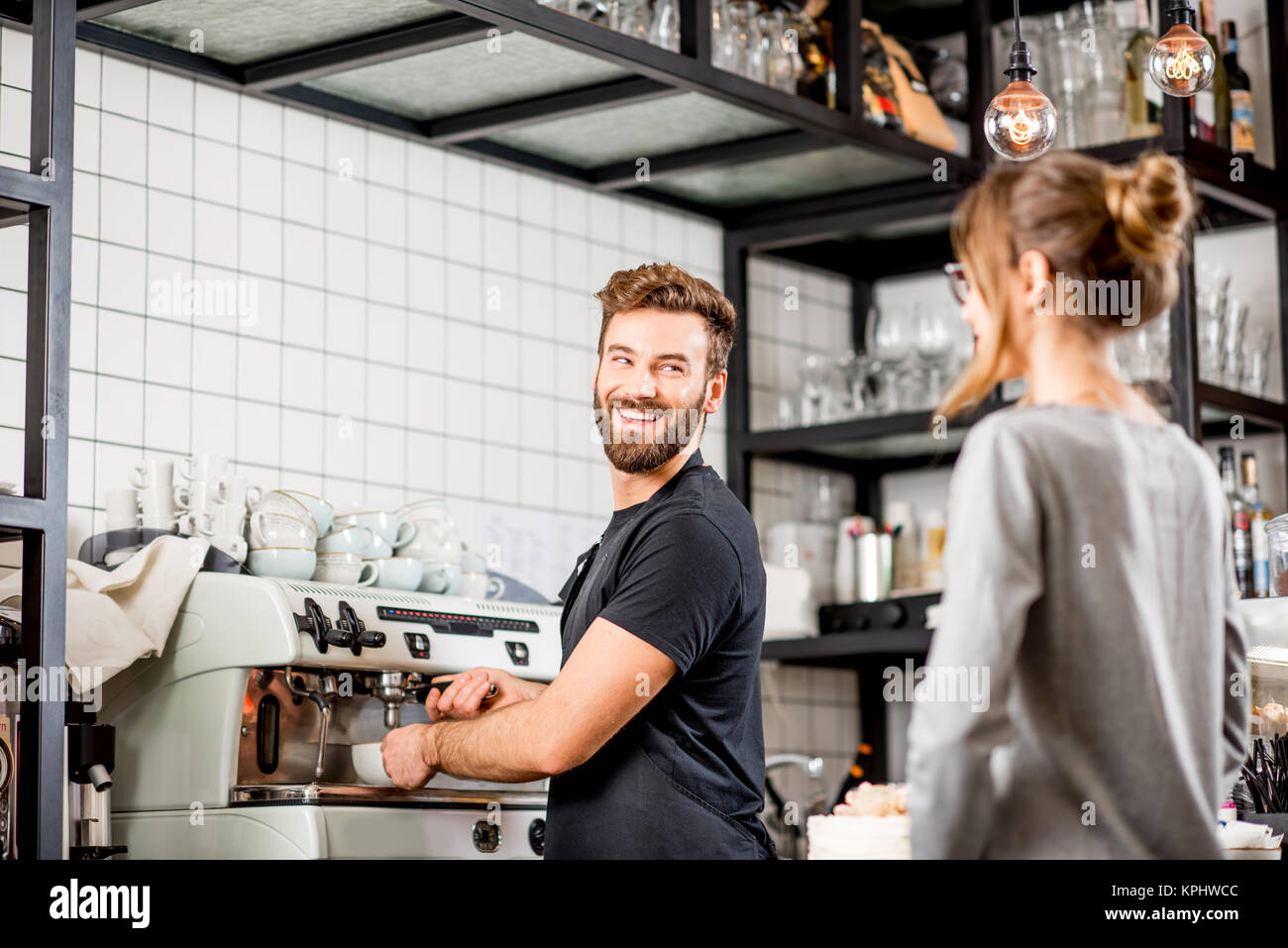 Barista with client at the cafe Stock Photo - Alamy