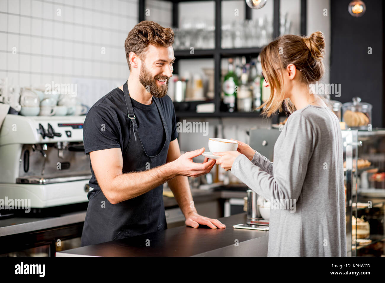 Barista with client at the cafe Stock Photo - Alamy