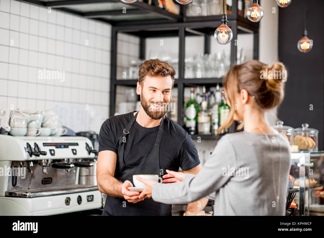 Barista with client at the cafe Stock Photo - Alamy