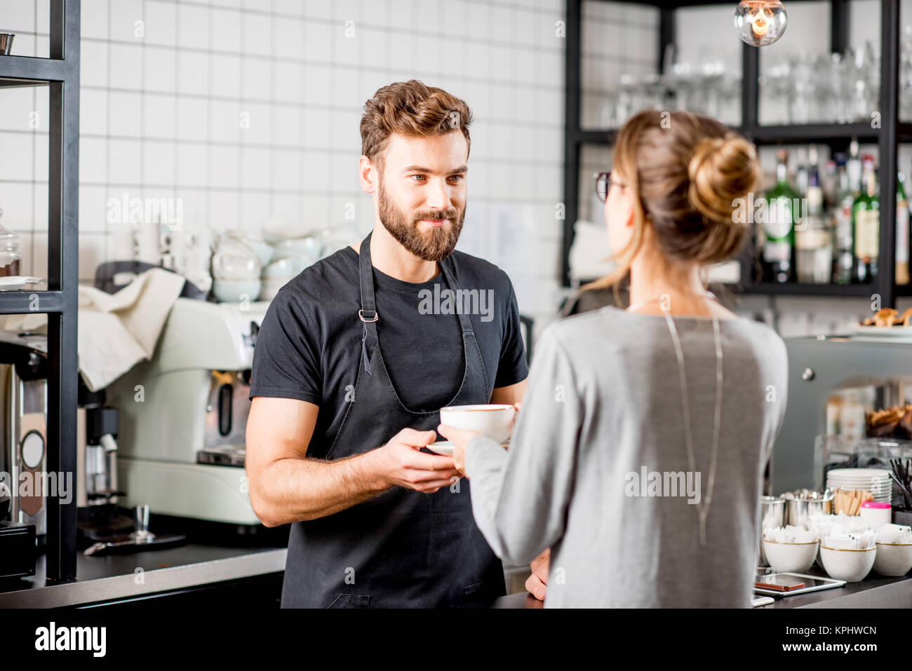 Barista with client at the cafe Stock Photo - Alamy
