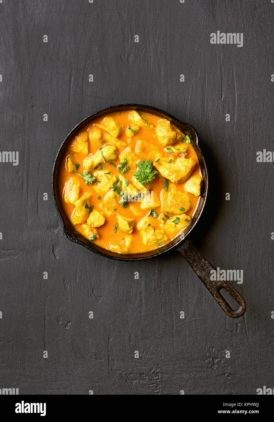 Chicken curry on black stone background with copy space. Top view, flat ...