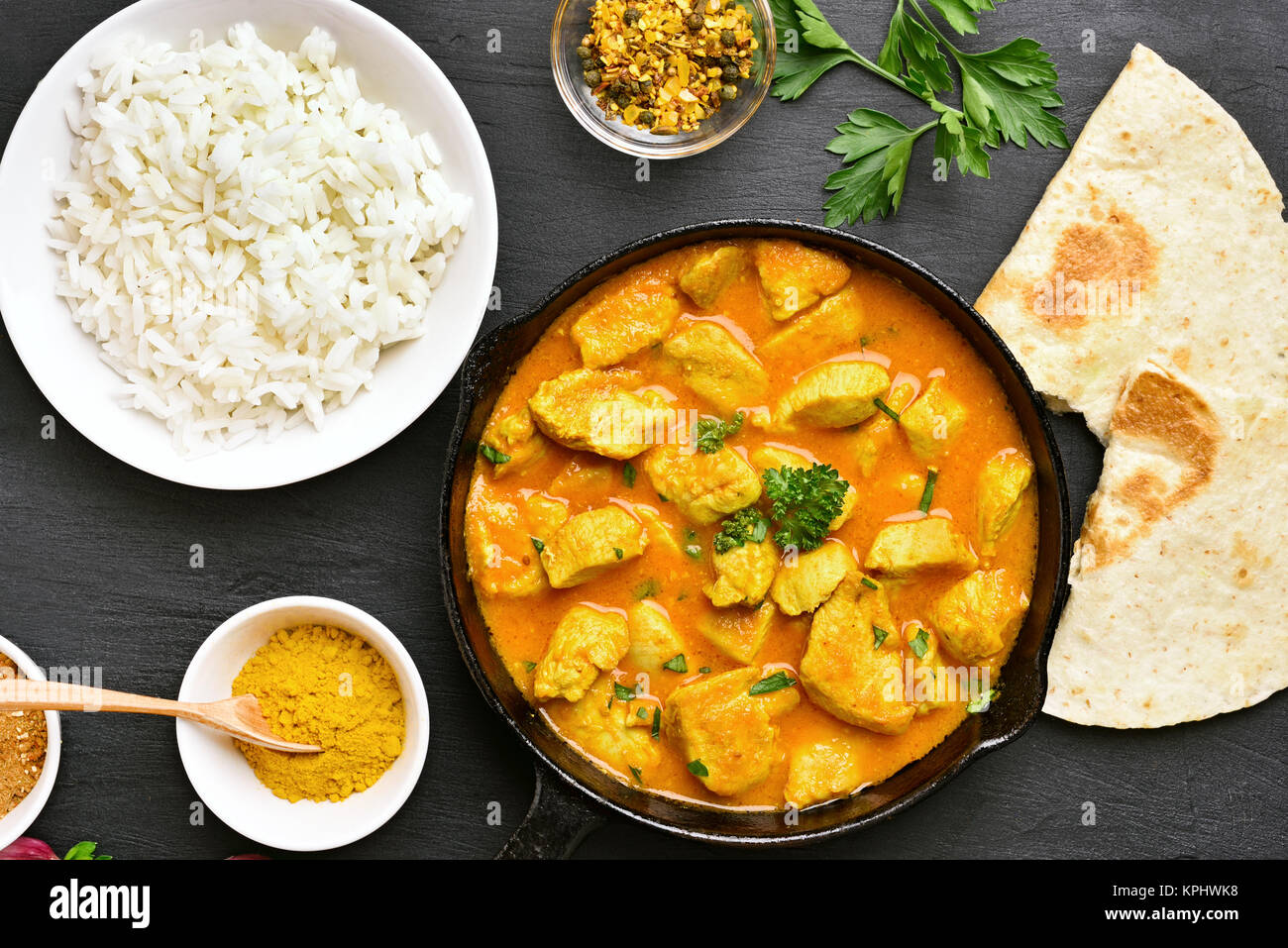 Indian chicken curry on black stone background. Top view, flat lay food ...