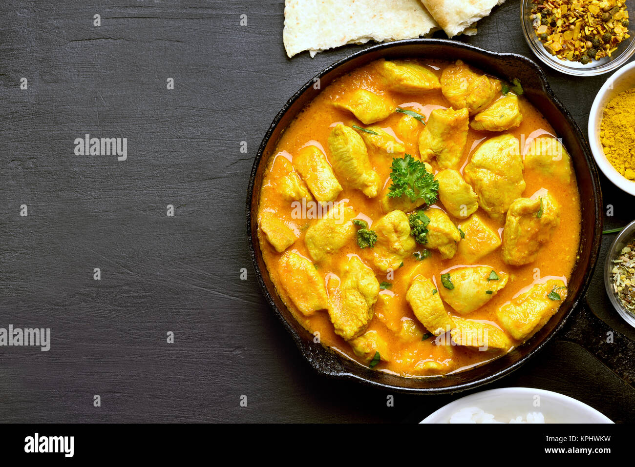 Indian chicken curry on black stone background with copy space. Top ...