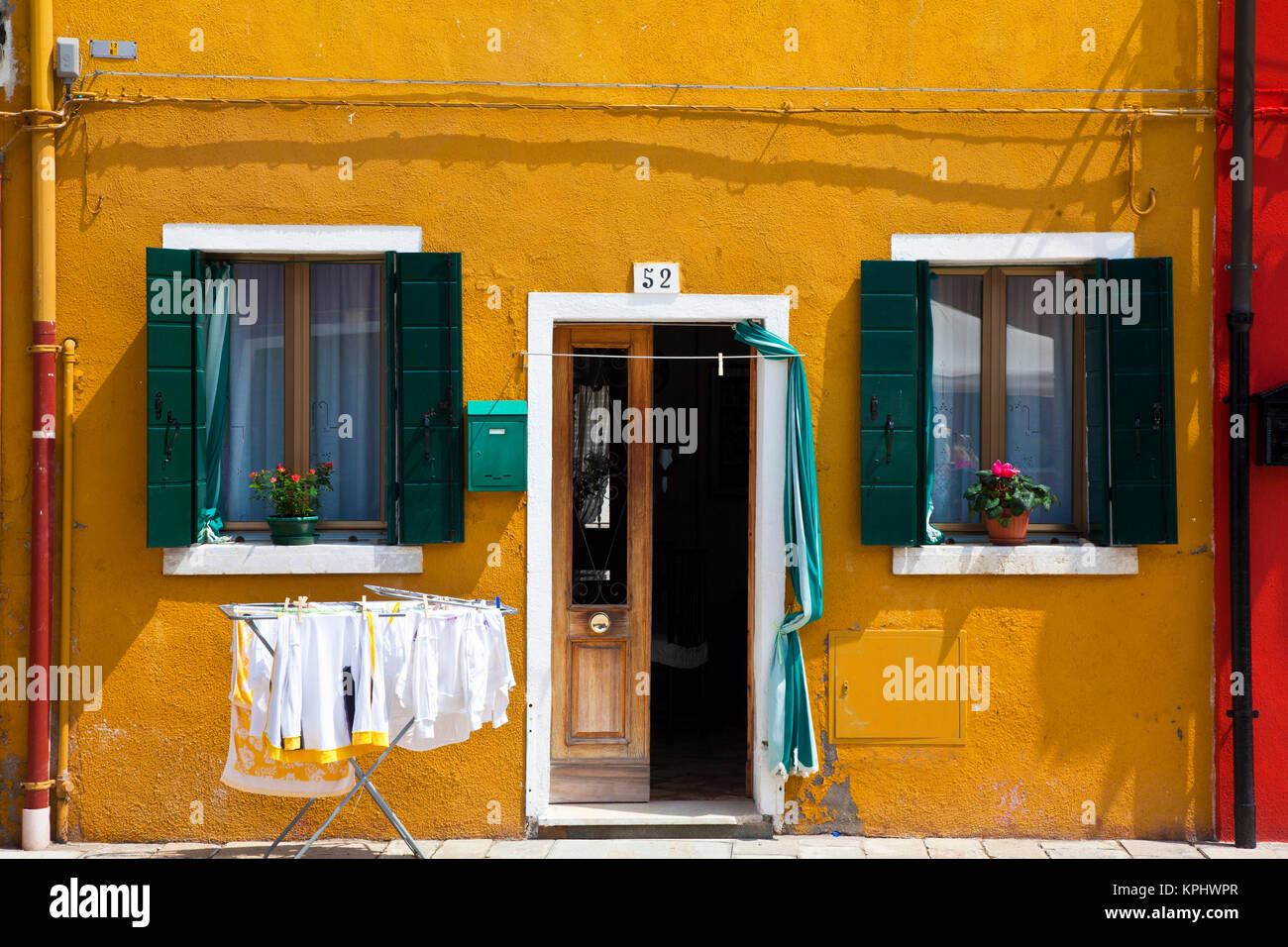 Europe. Italy. Burano. Bright Colored Home with Laundry Out Stock Photo ...