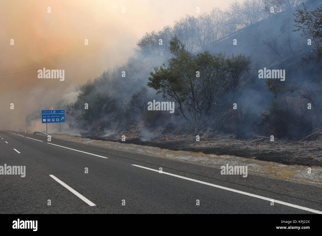 Fire on the road Stock Photo - Alamy