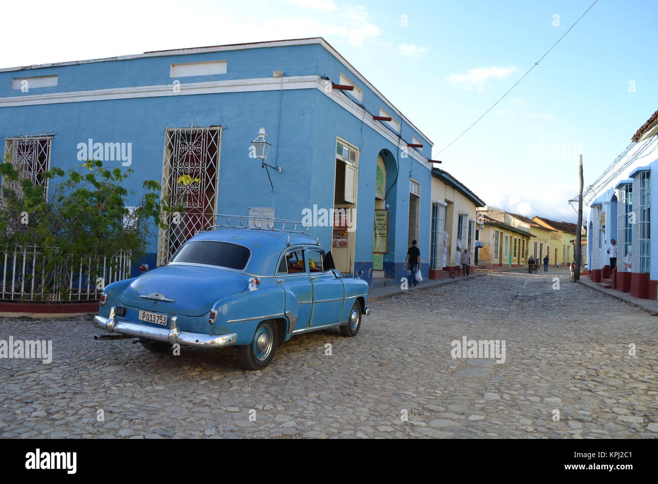 Azure vintage car on azure background buildings in Trinidad, Cuba Stock ...