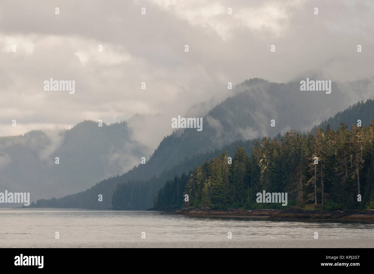USA, AK, Inside Passage. Classic Inside Passage scenery, light breaks ...