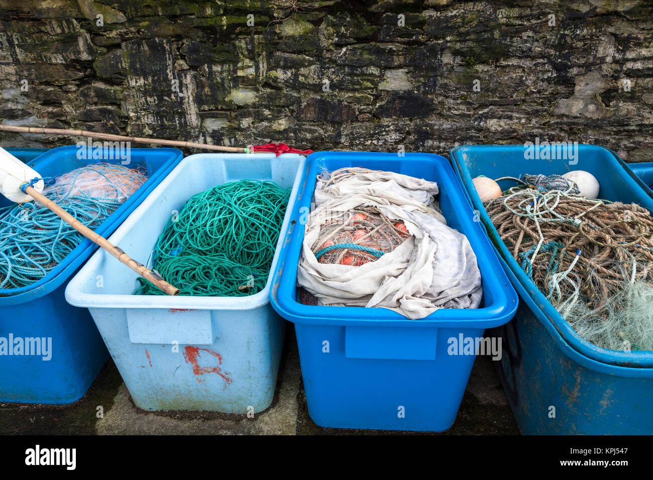 Large plastic boxes filled with fishing nets, floats etc on the ...