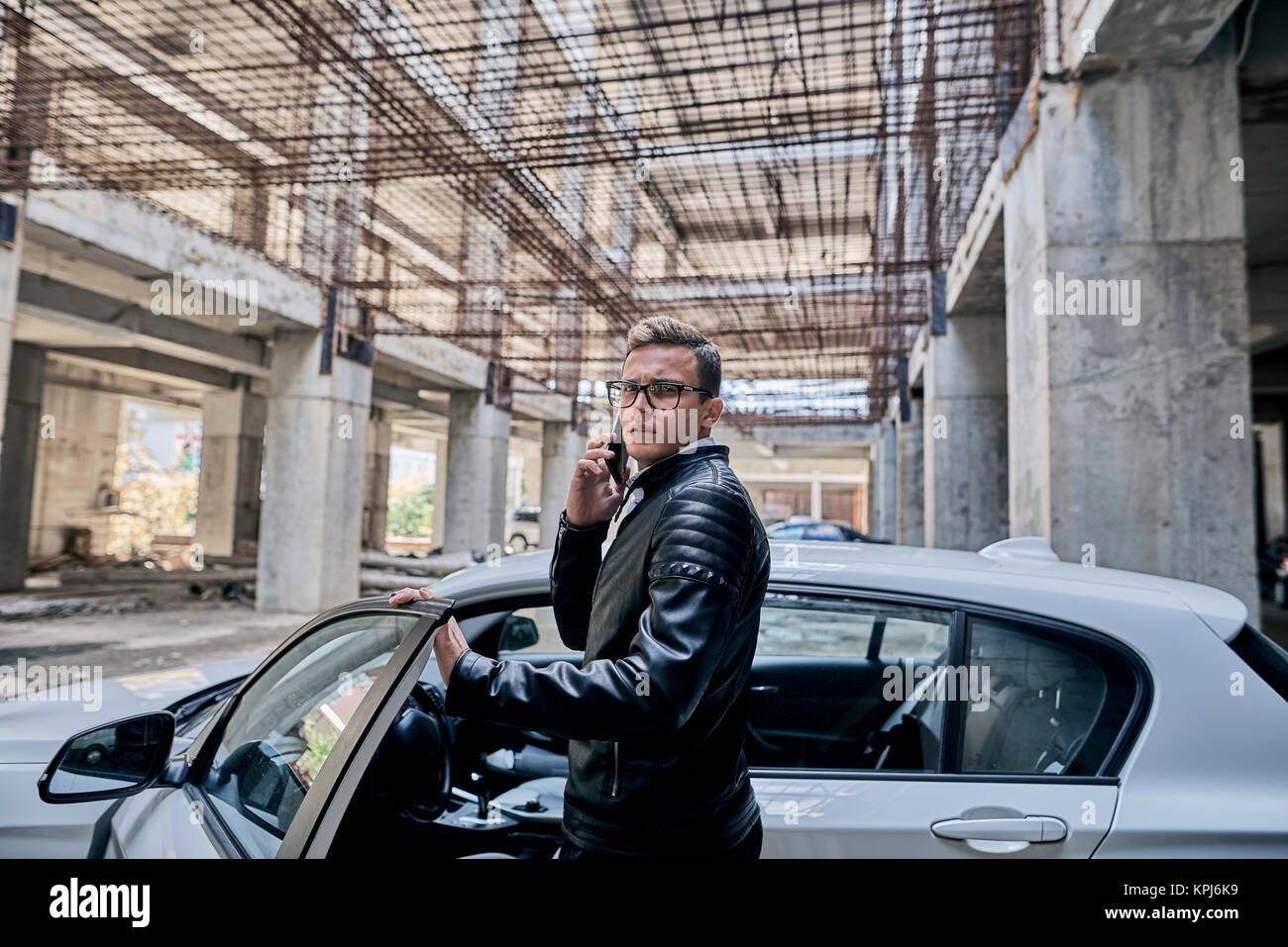 man gets out of the car Stock Photo - Alamy